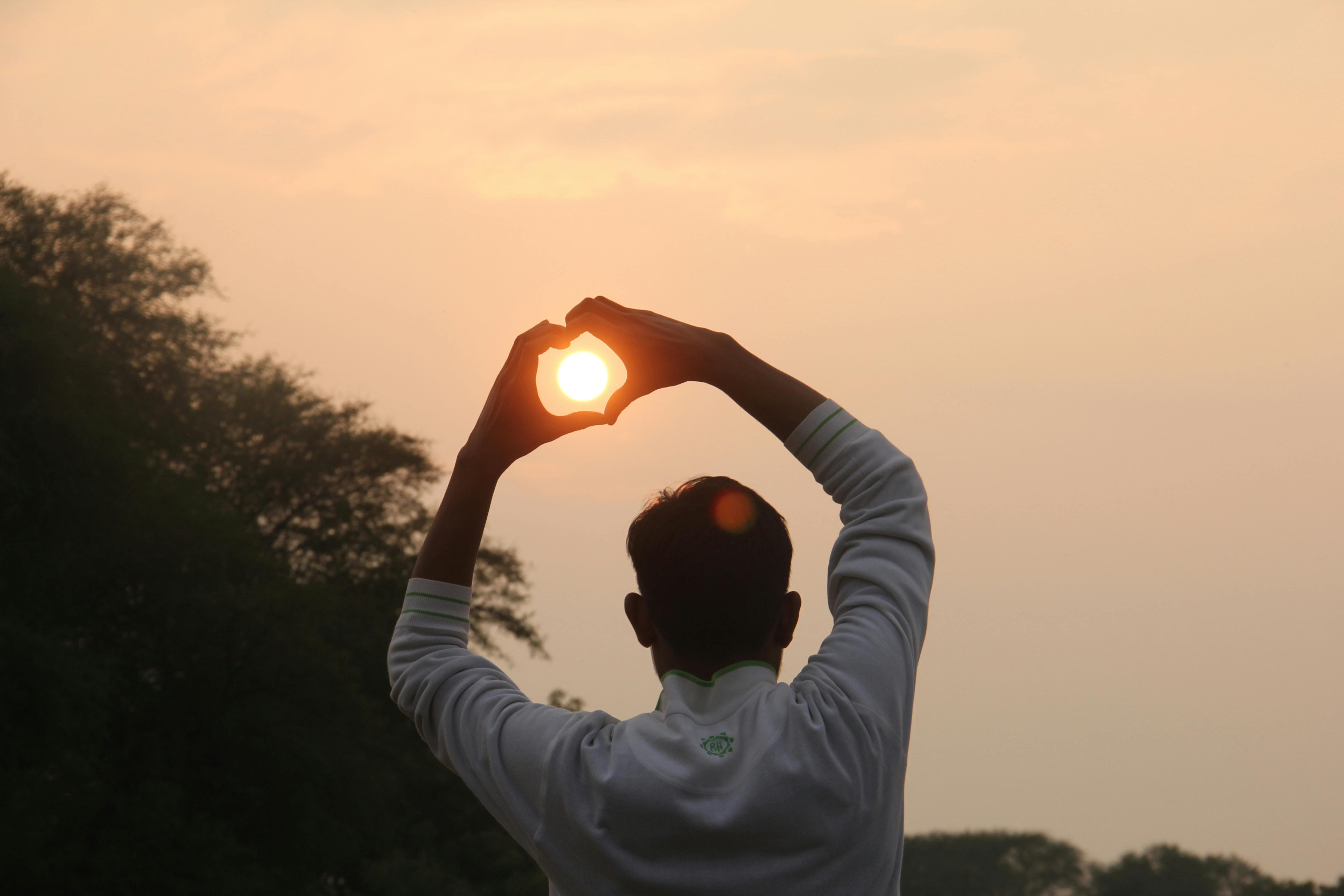 Man Doing a Heart Pose · Free Stock Photo