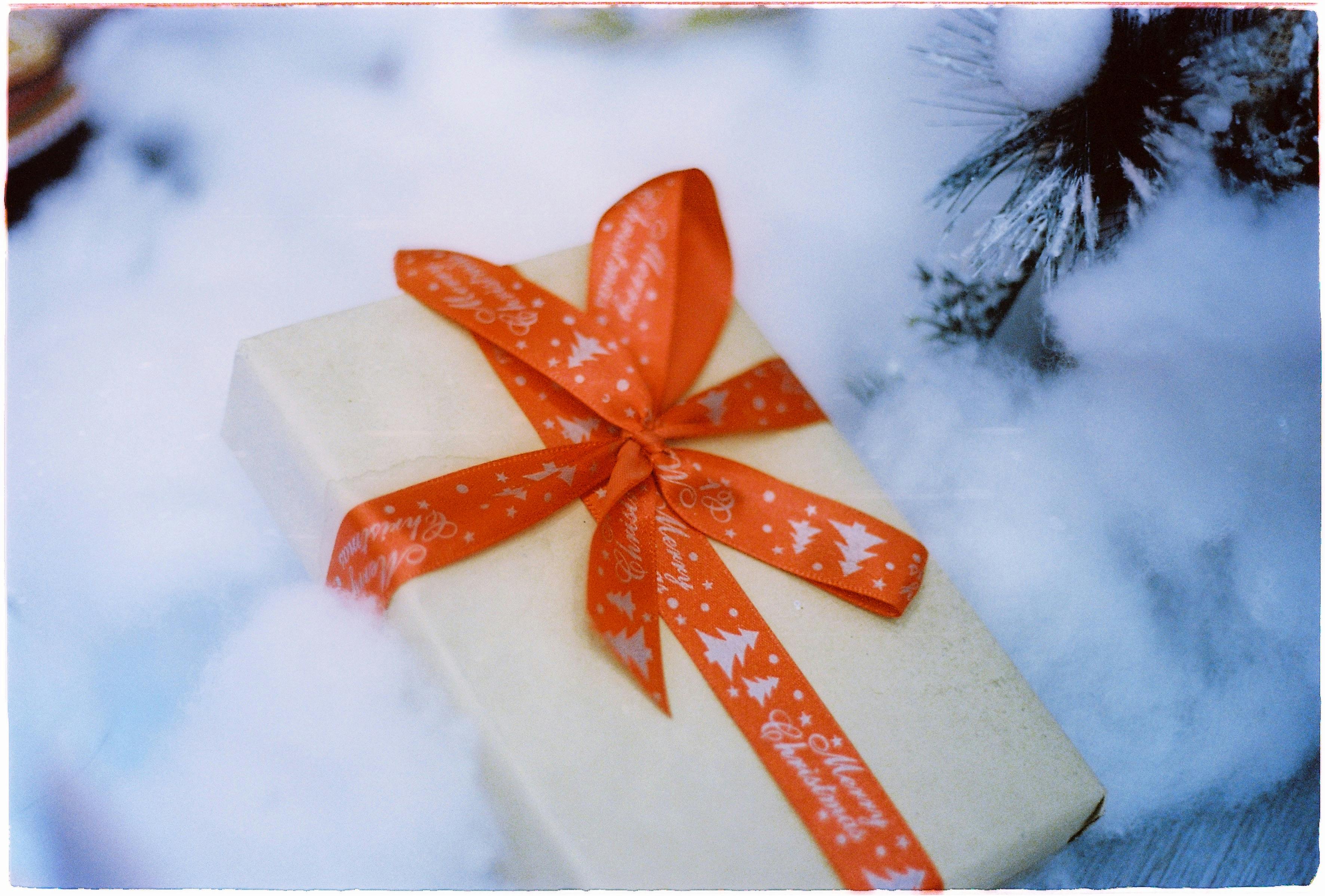 Woman Unwrapping a Christmas Present · Free Stock Photo