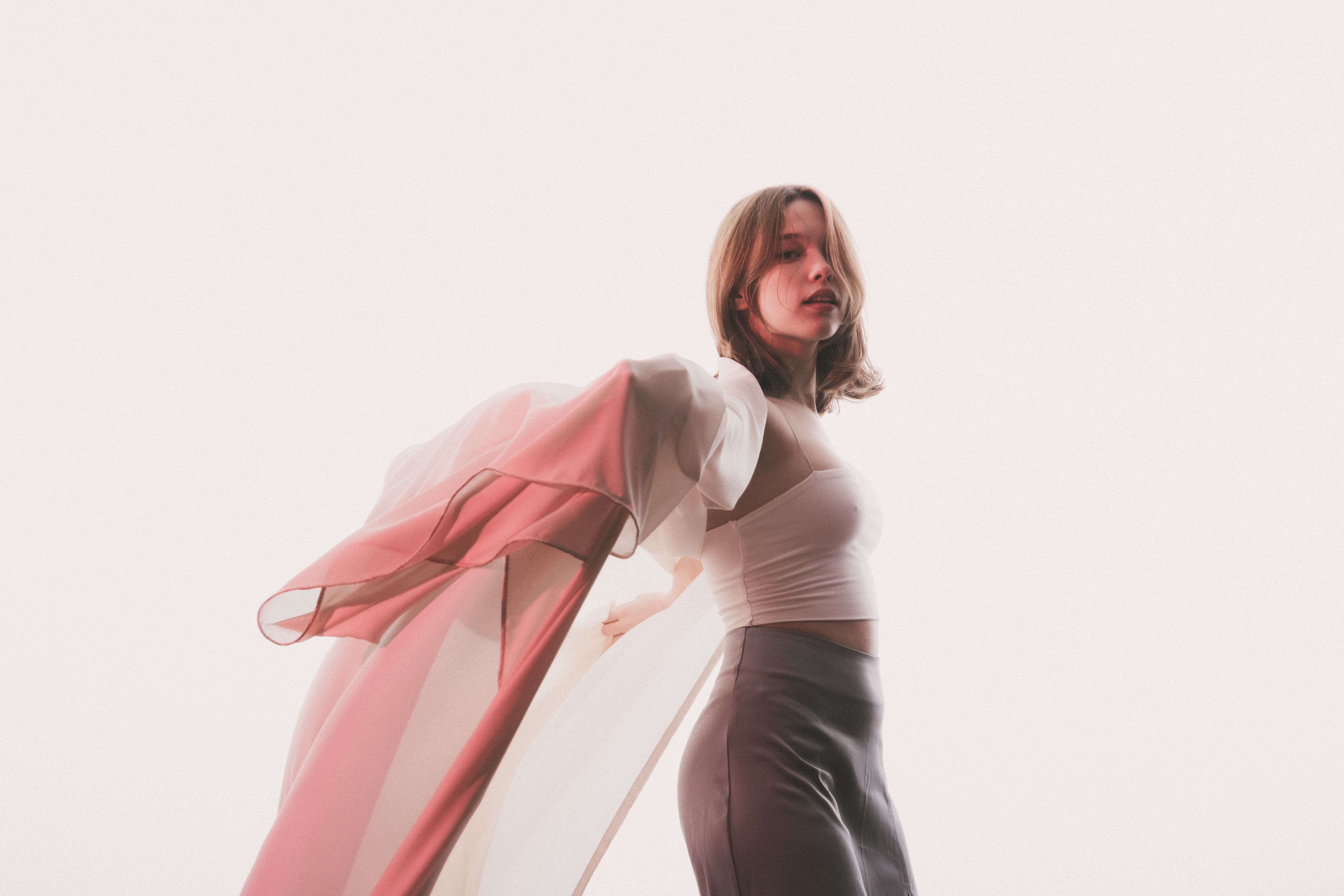 Young Woman Holding a Sheer Pink Fabric · Free Stock Photo