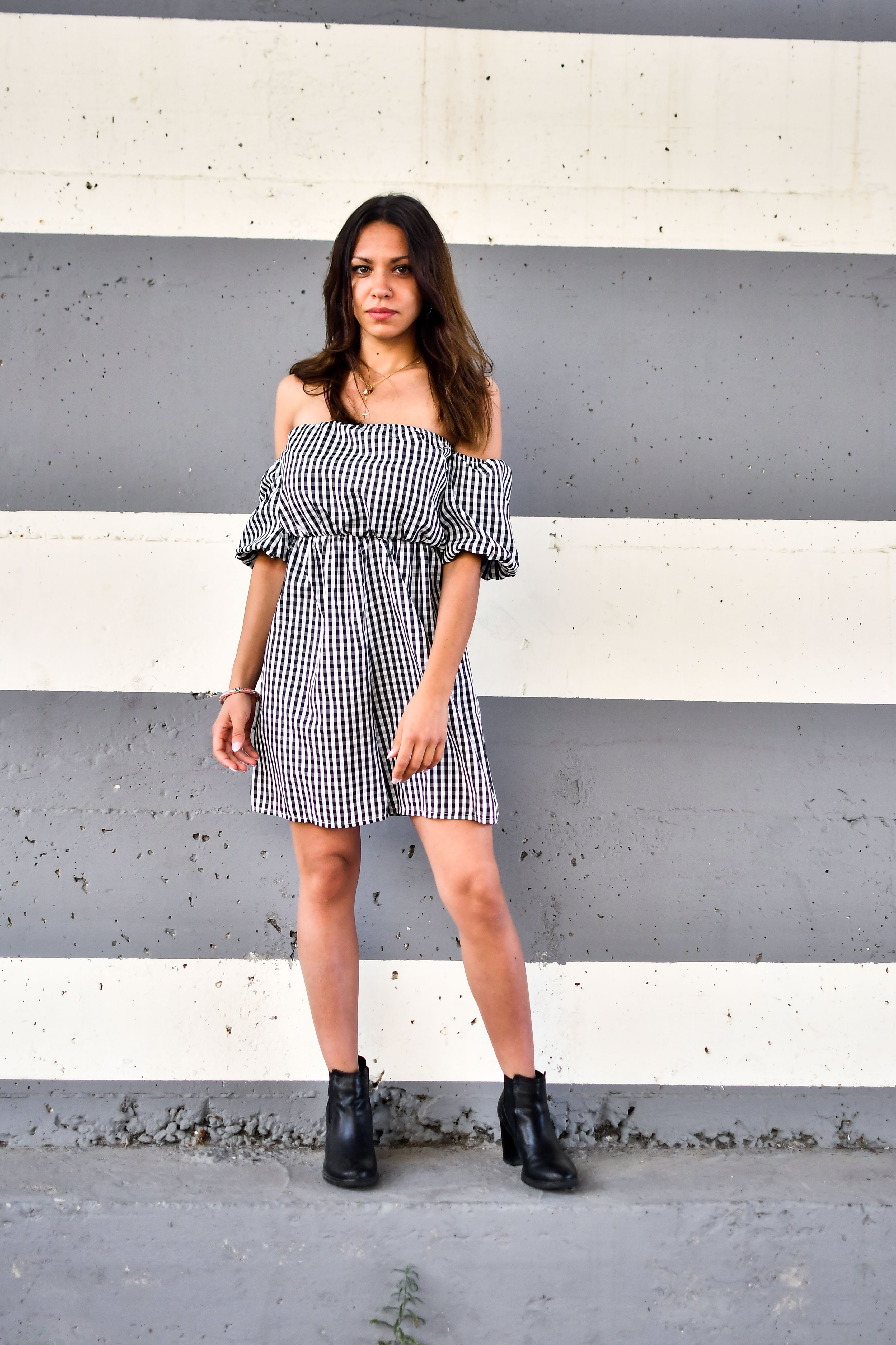Woman in a Black and White Dress Wearing Black Shoes · Free Stock Photo