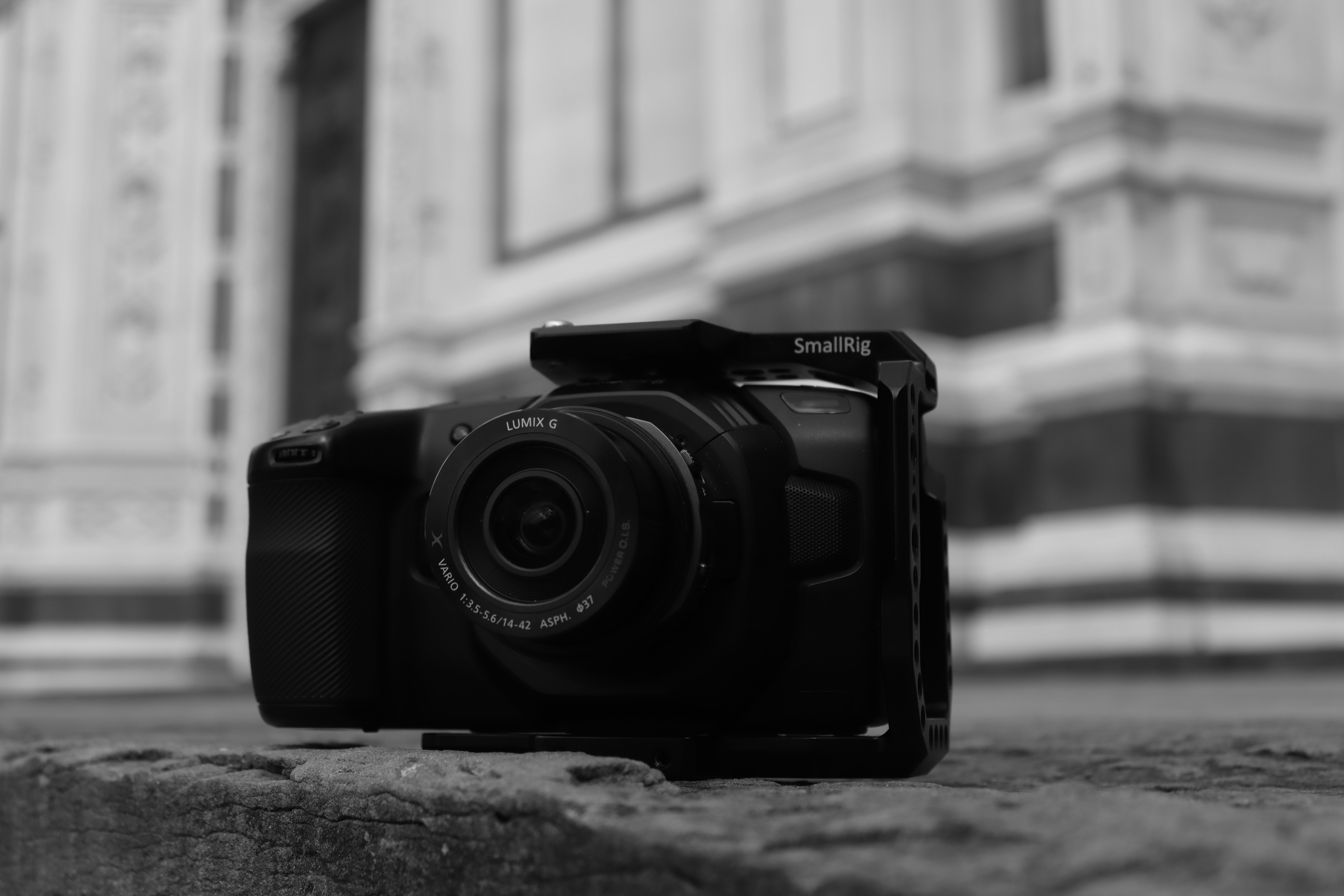 A Grayscale Photo of a Camera on a Concrete Surface · Free Stock Photo