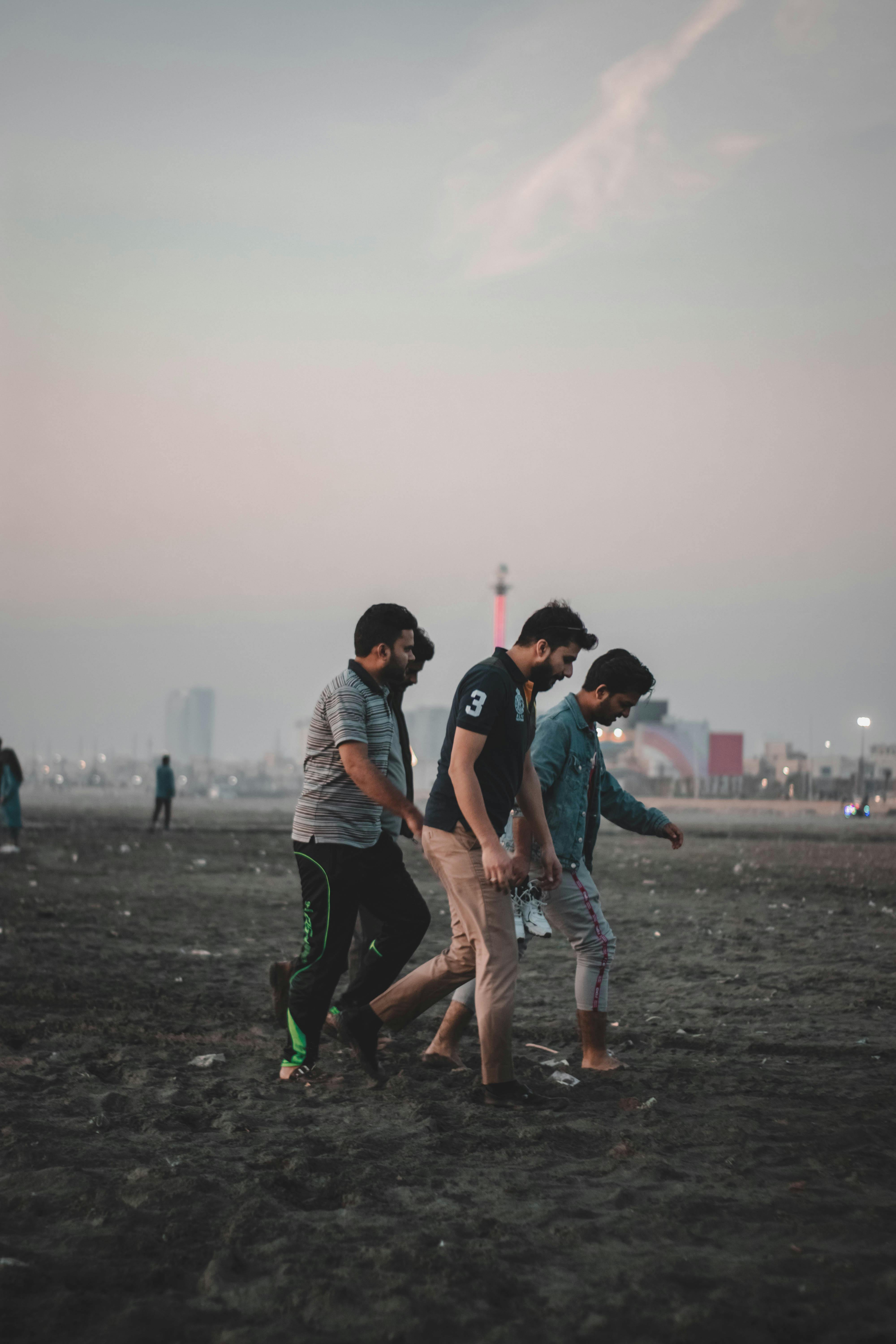 Group of Indian Men Walking on the Outskirts of a City · Free Stock Photo