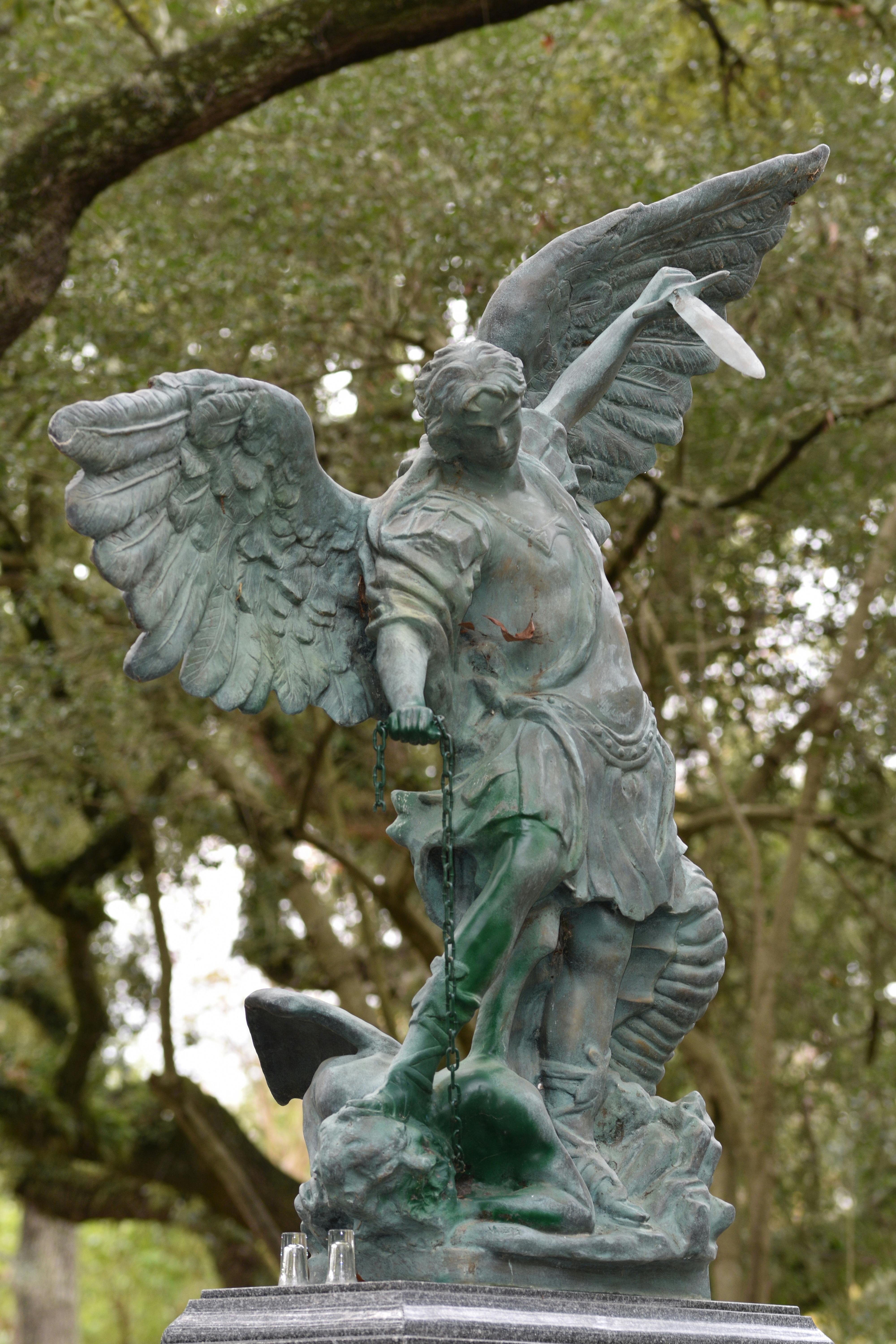 Statue of an Angel against Trees in a Park · Free Stock Photo