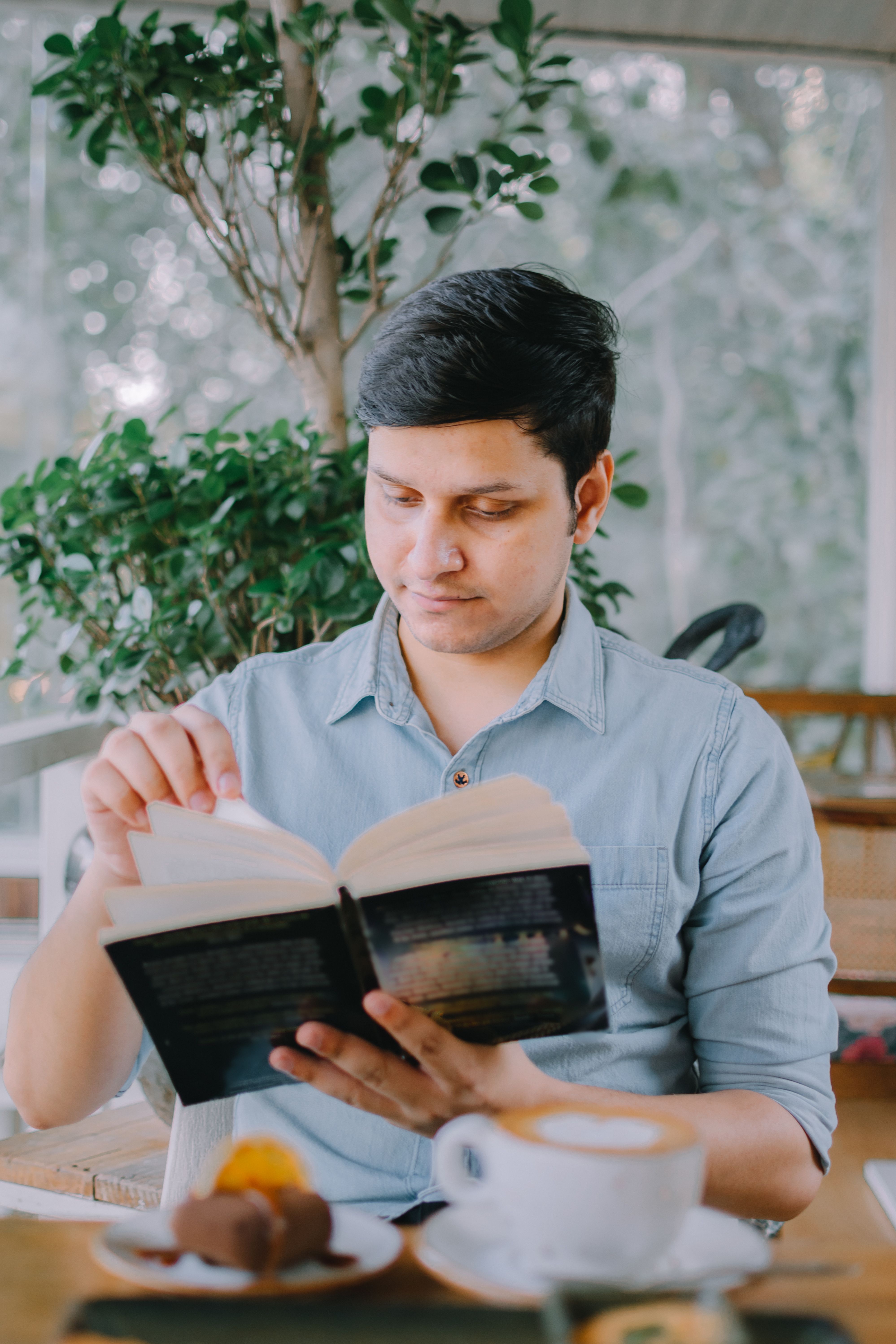 A Person Lying on Front Reading Book · Free Stock Photo