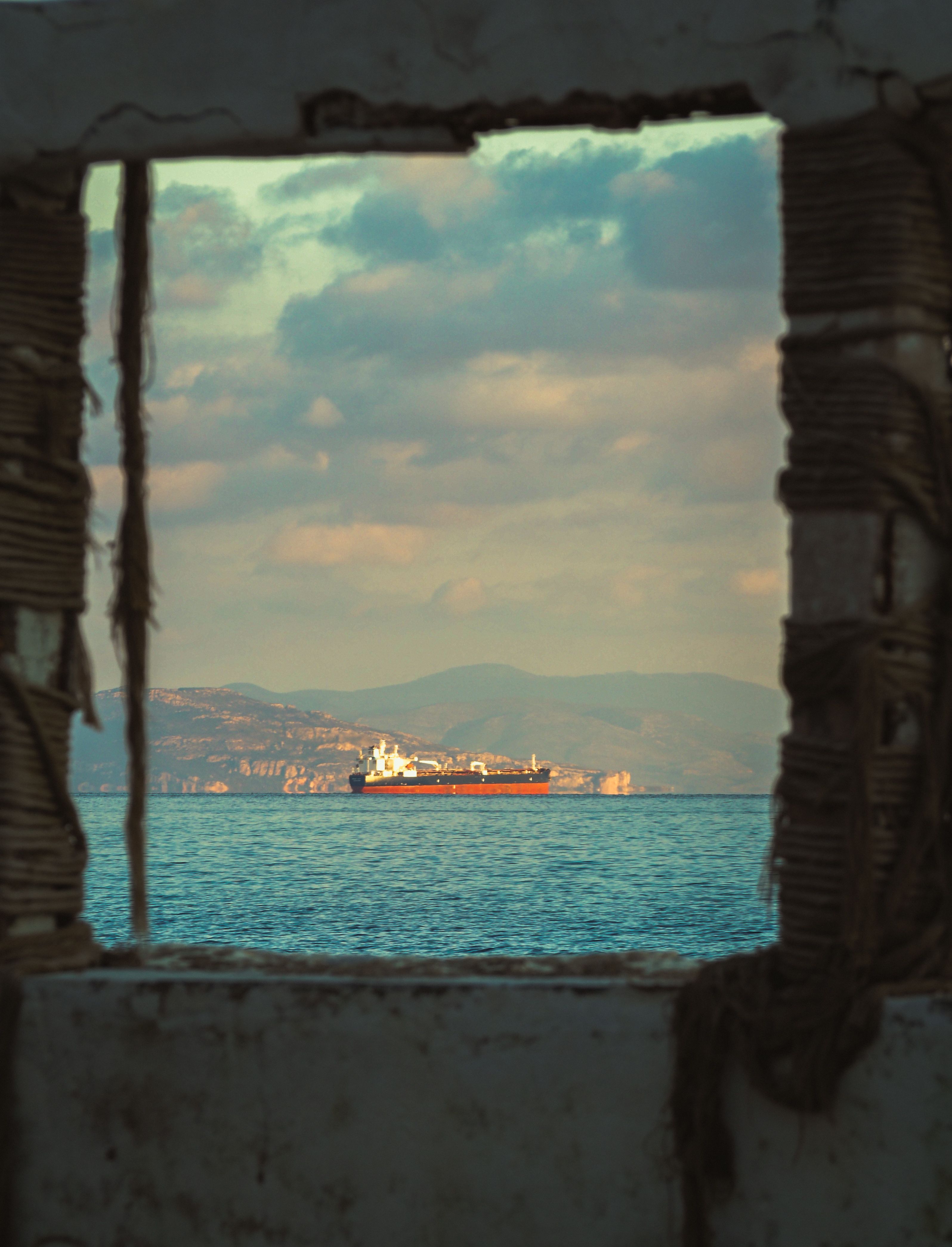 Vessel on Sea behind Damaged Window · Free Stock Photo