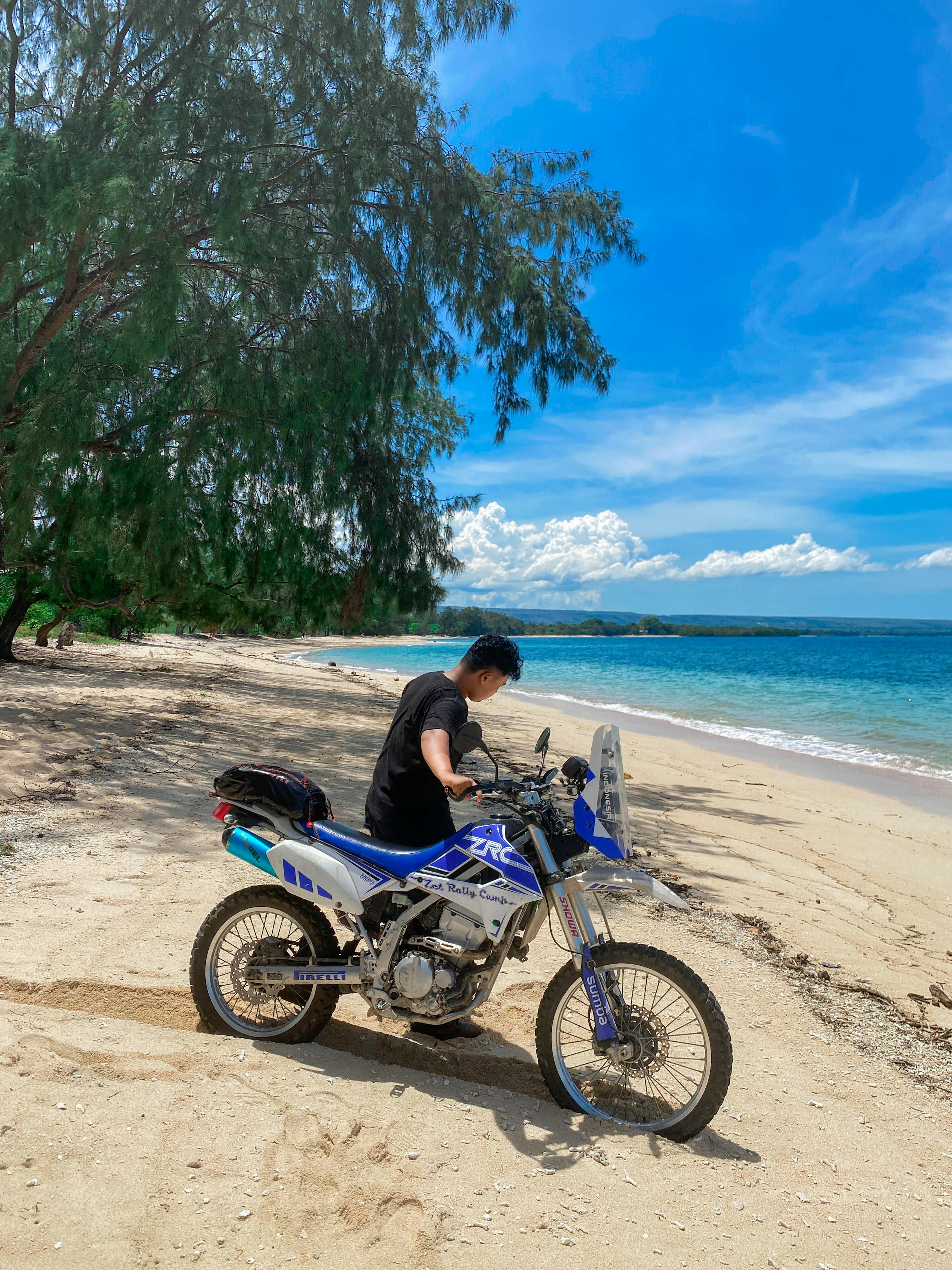 Man and His Blue Motorbike at the Beach · Free Stock Photo