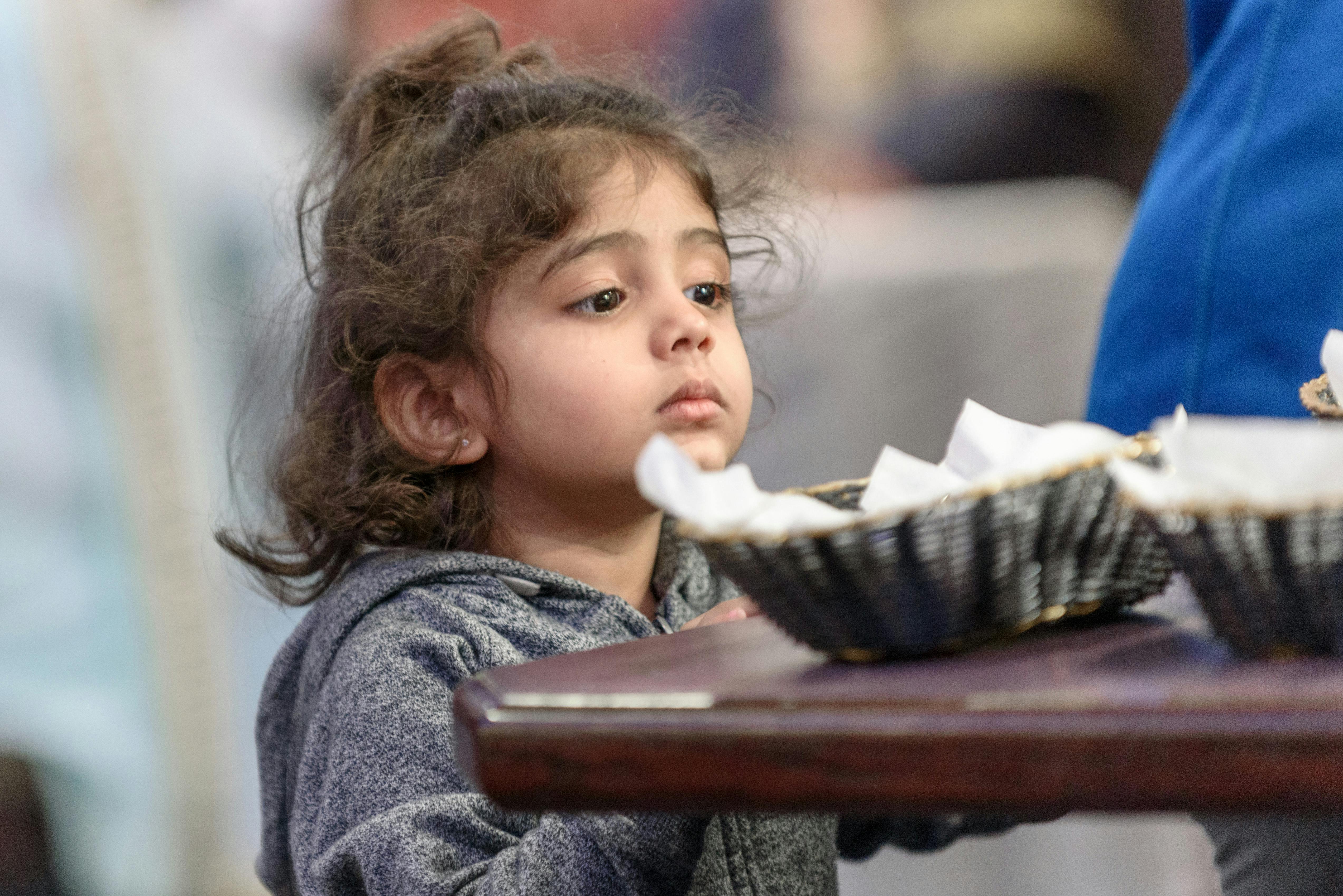 Photograph of a Child Looking Over a Table · Free Stock Photo