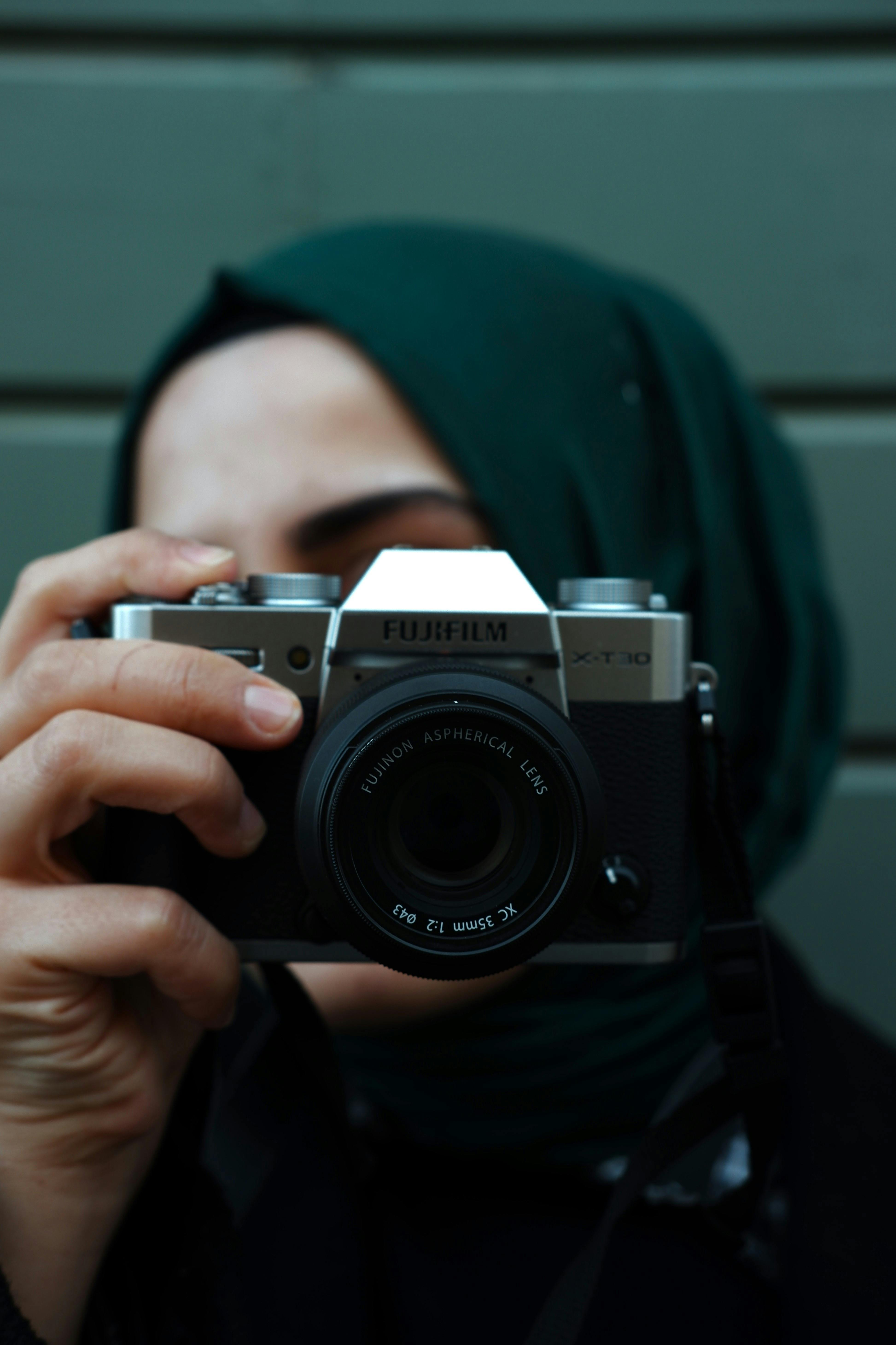 Close-Up Shot of a Person Holding a Camera · Free Stock Photo