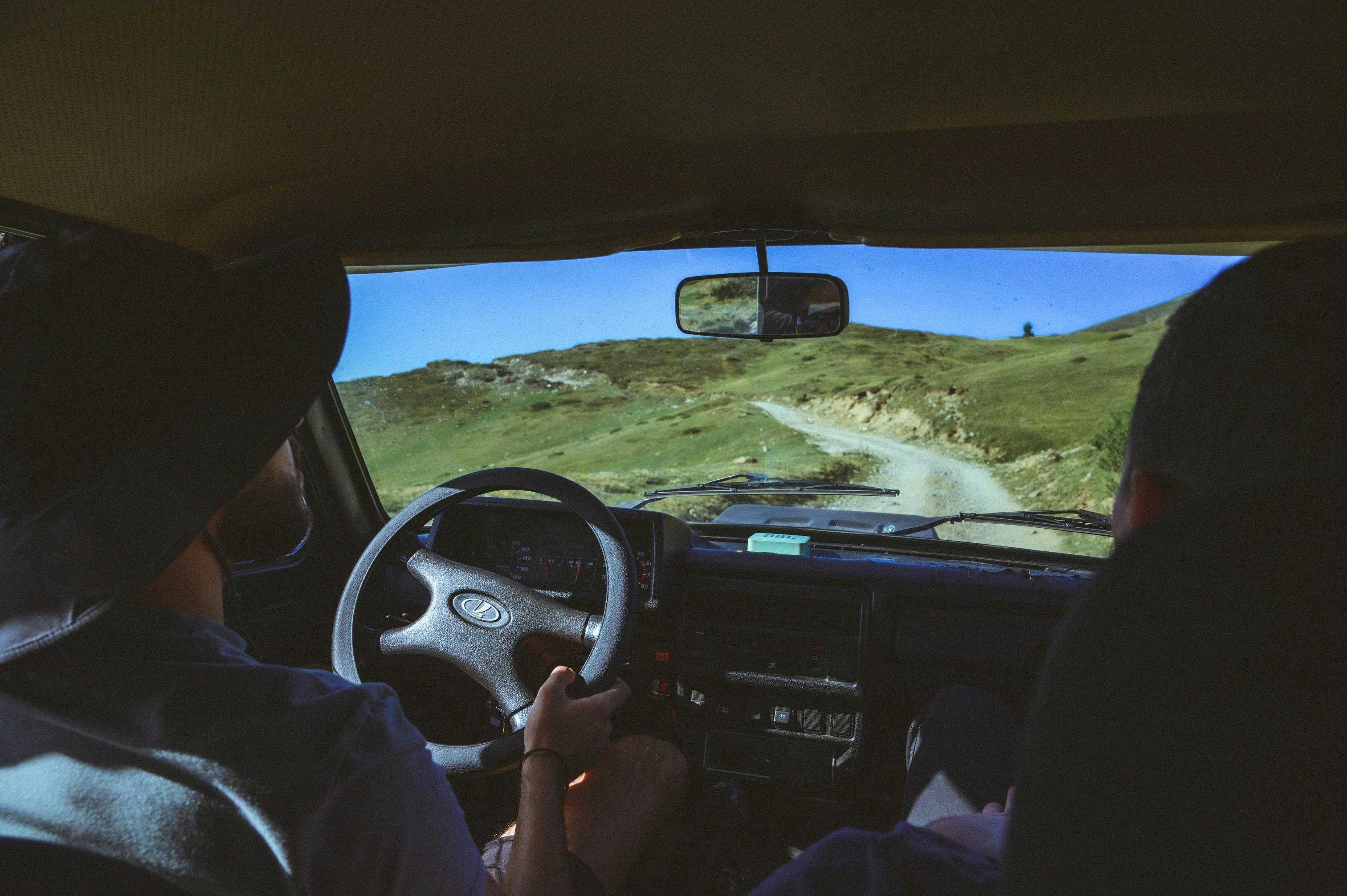Two People Driving in a Car · Free Stock Photo
