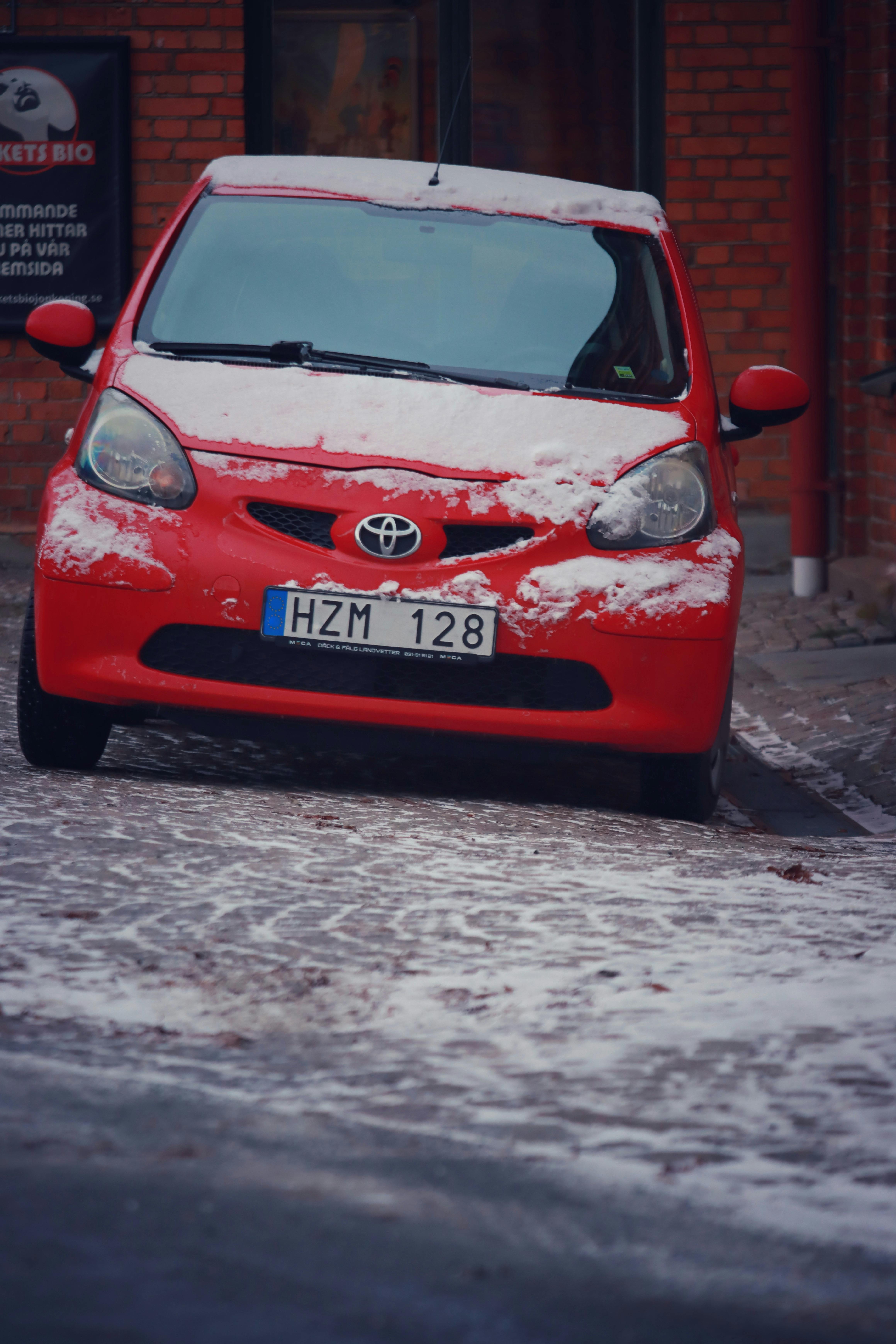 A Red Car Covered with Snow · Free Stock Photo