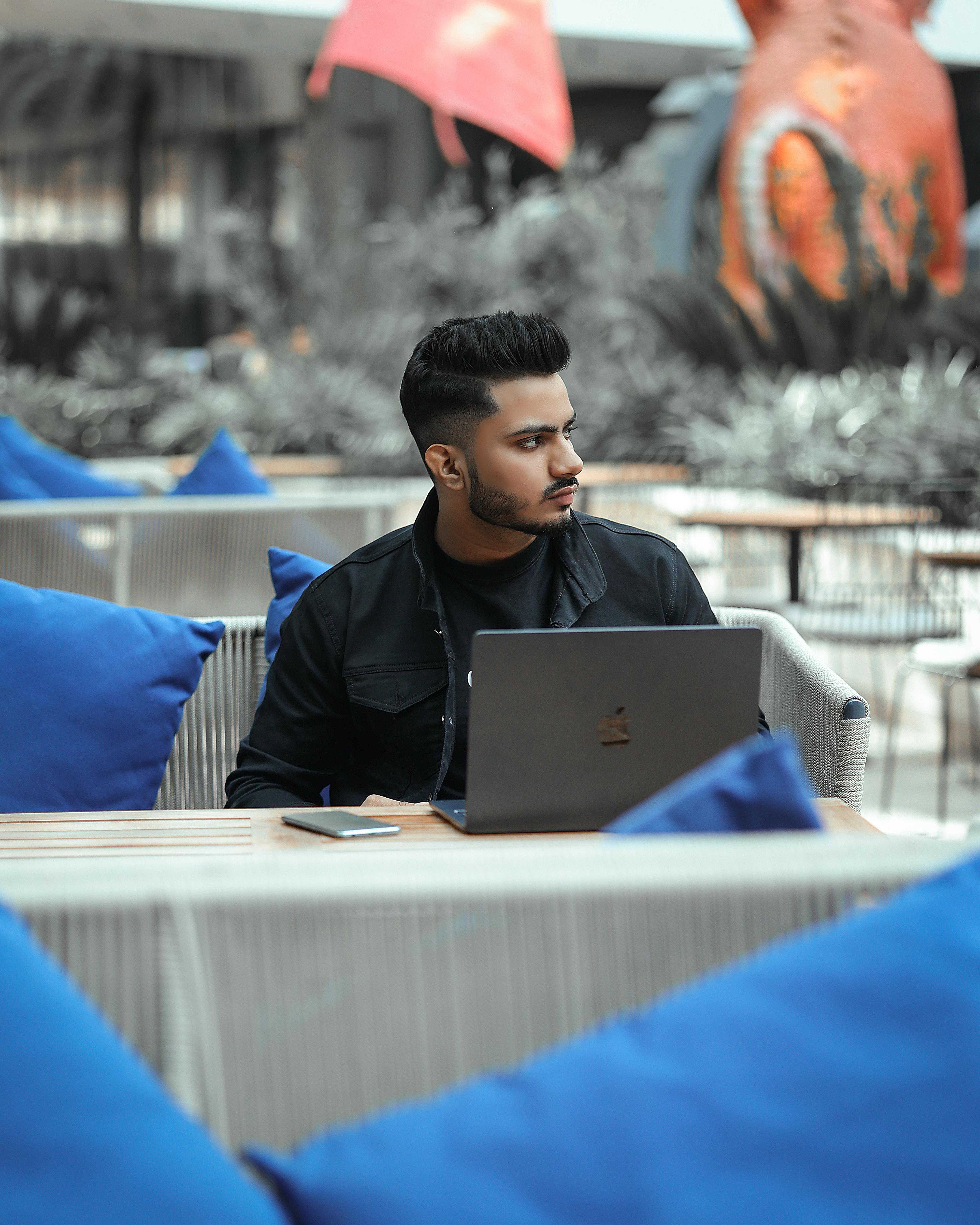 Man Sitting with a Laptop · Free Stock Photo