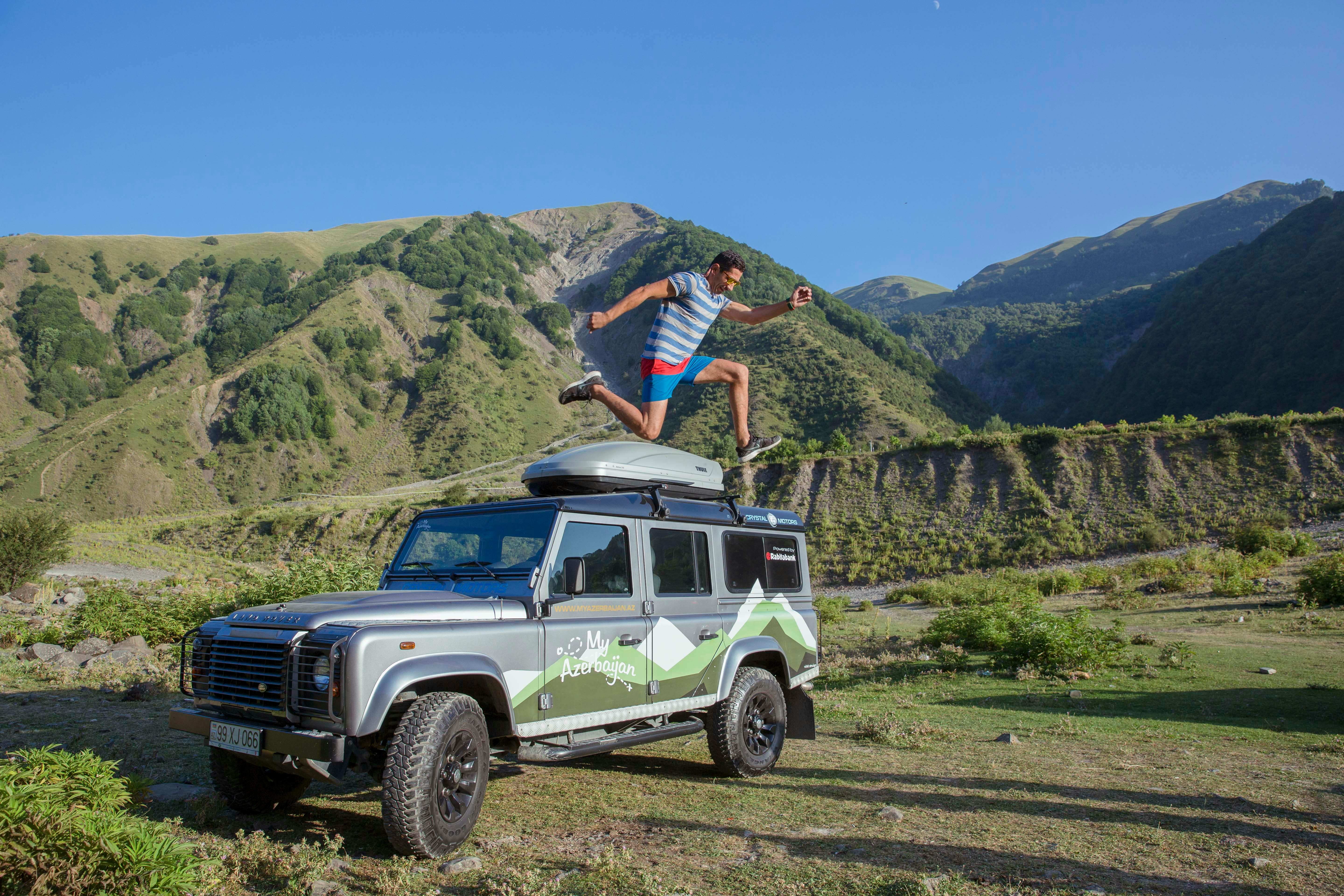 Man Jumping over 4x4 Car in Mountains · Free Stock Photo