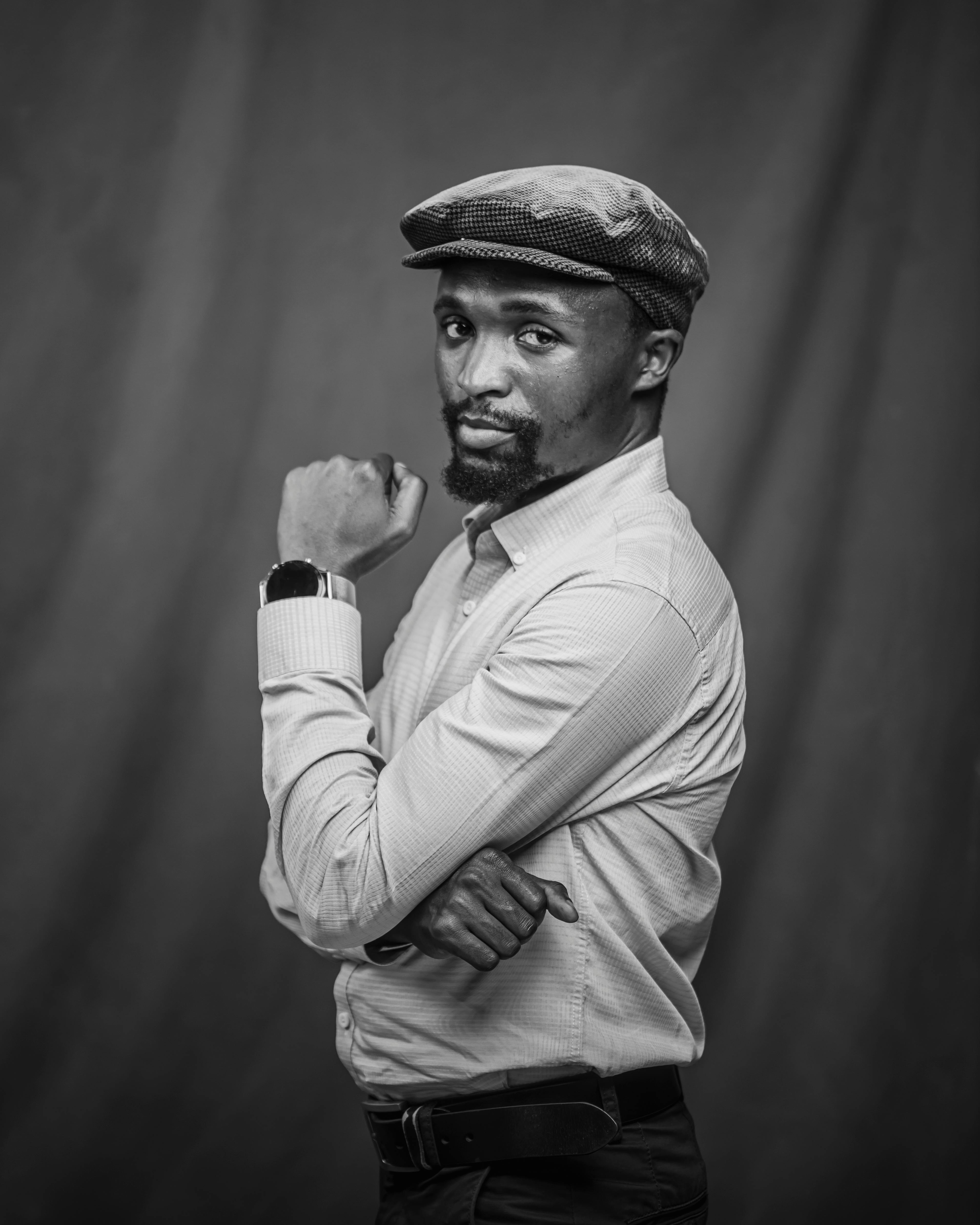 Black and White Shot of a Man Wearing Shirt and Hat · Free Stock Photo