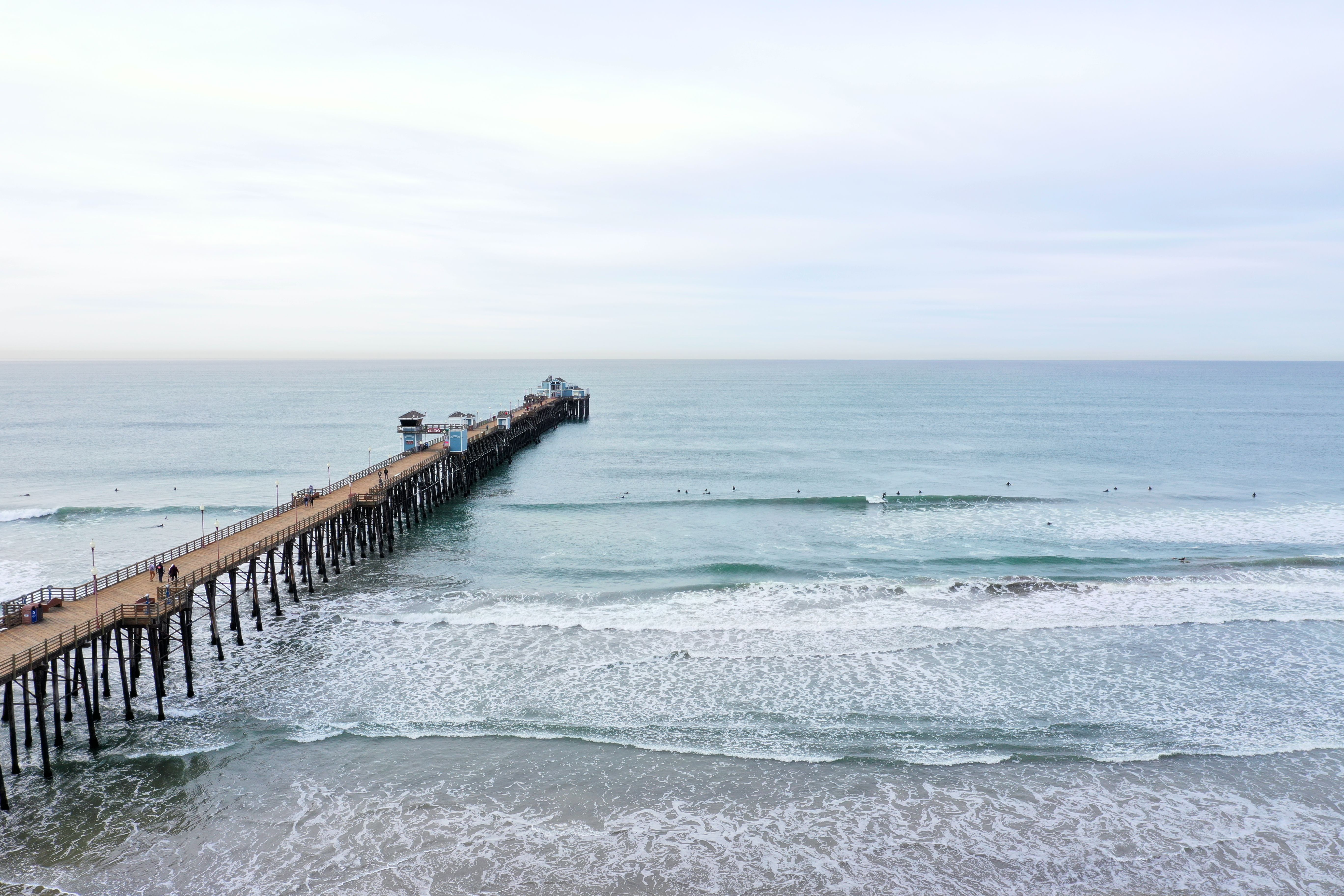 Aerial View of a Pier on the Shore with Clear Water in the Evening ...