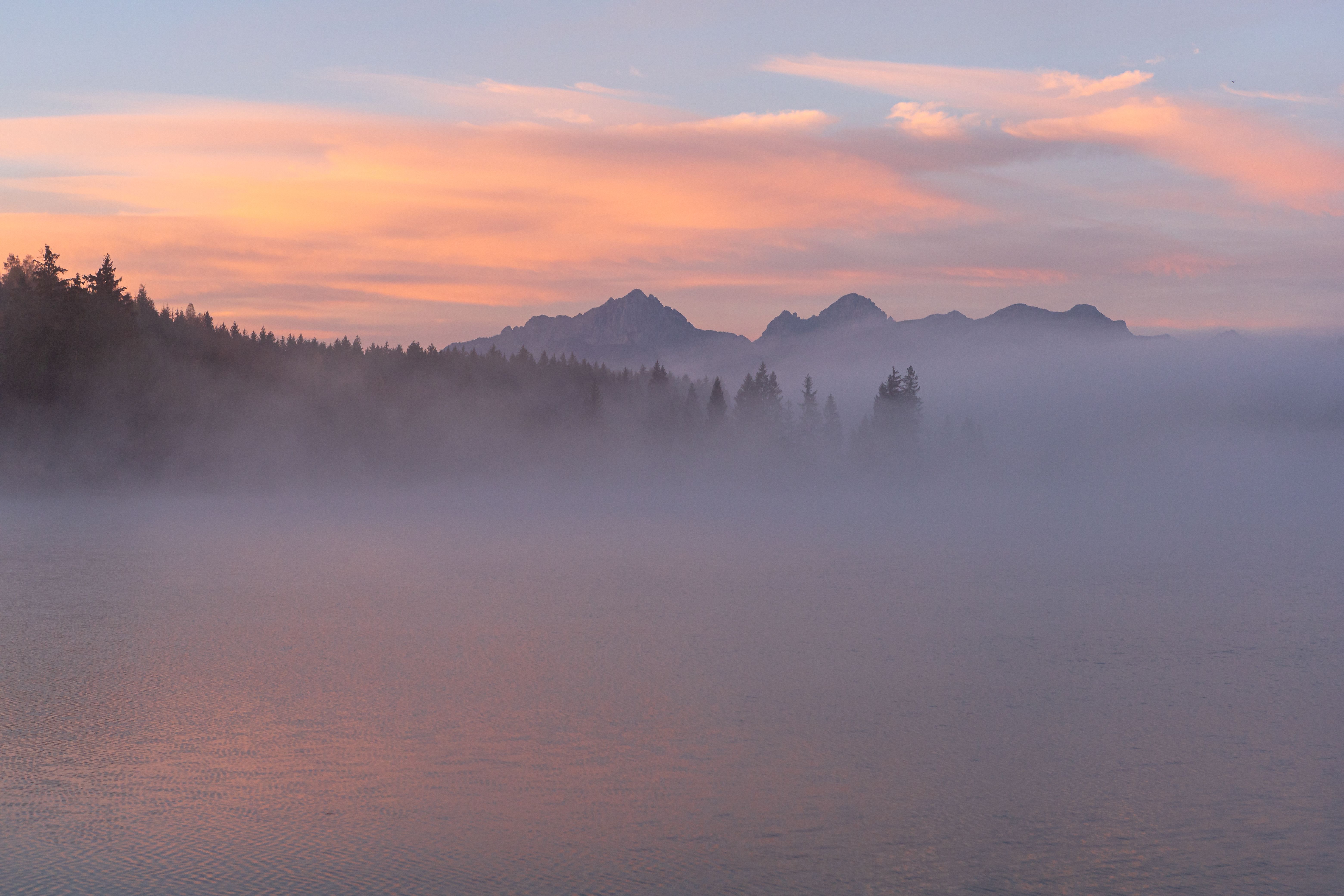 Fog over the Water and Mountains in Distance at Sunset · Free Stock Photo