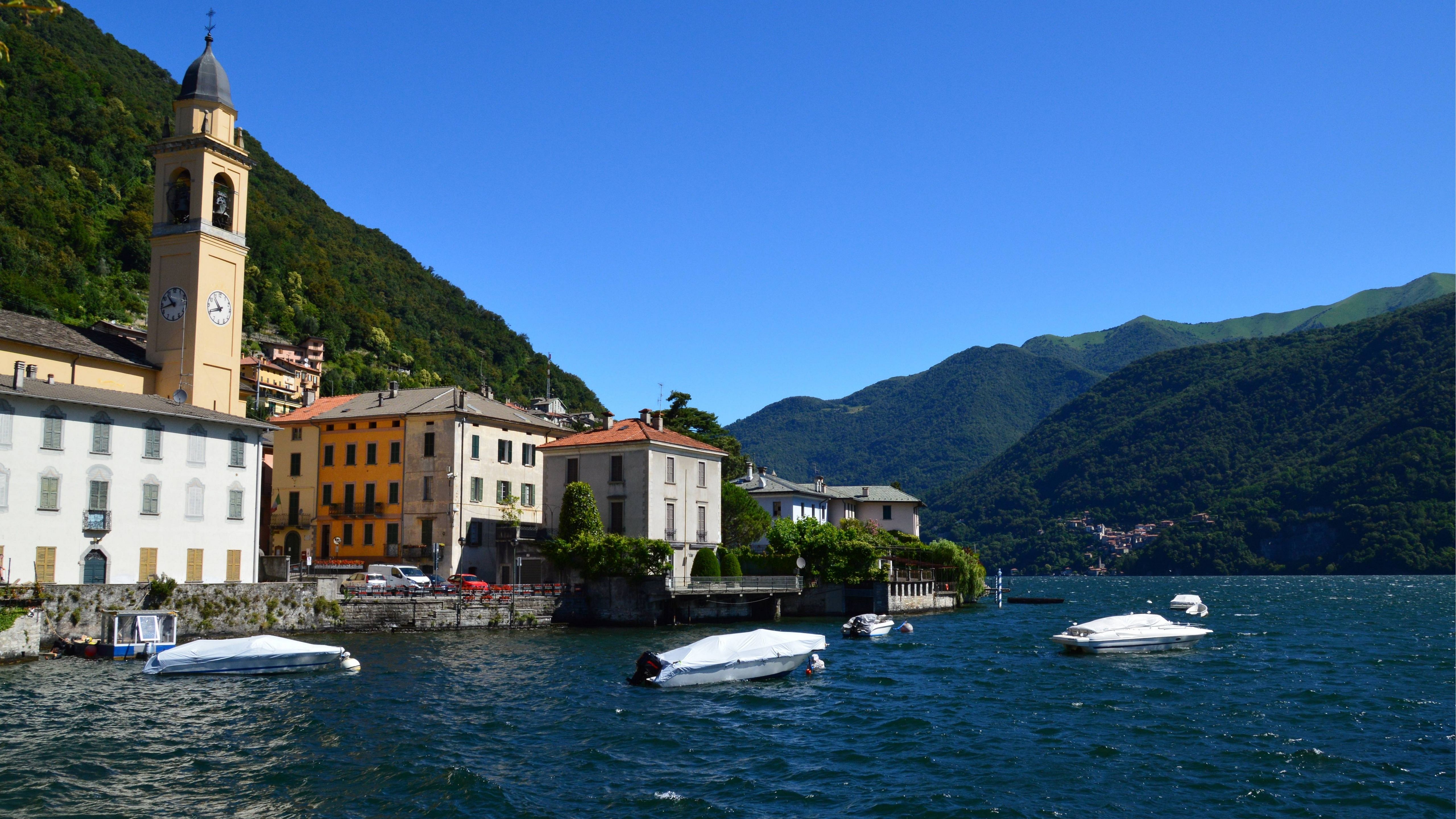 Motorboat Sailing on Lake Como Surrounded by Alps · Free Stock Photo