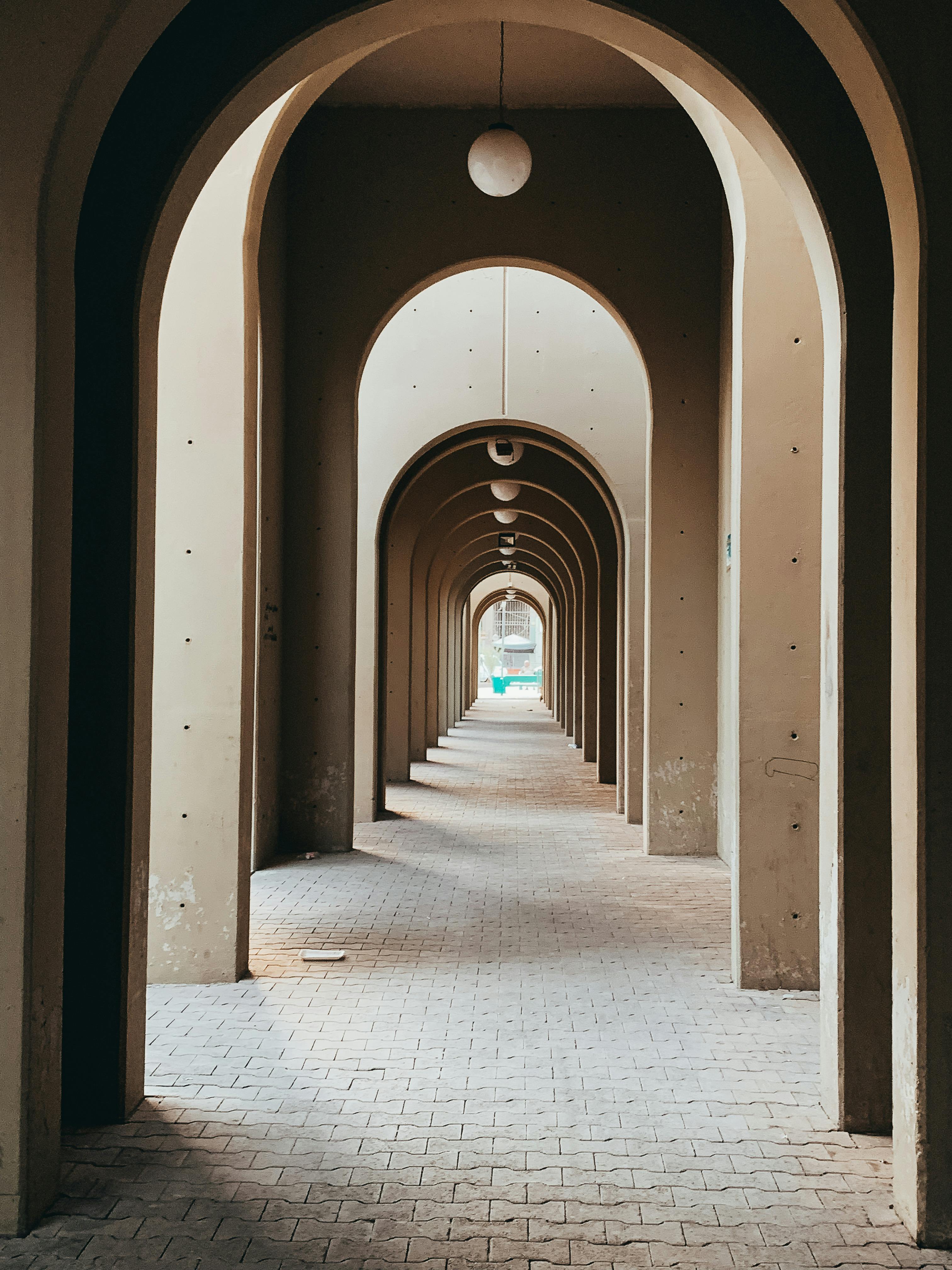 Symmetrical View of a Corridor with an Arched Entrance · Free Stock Photo