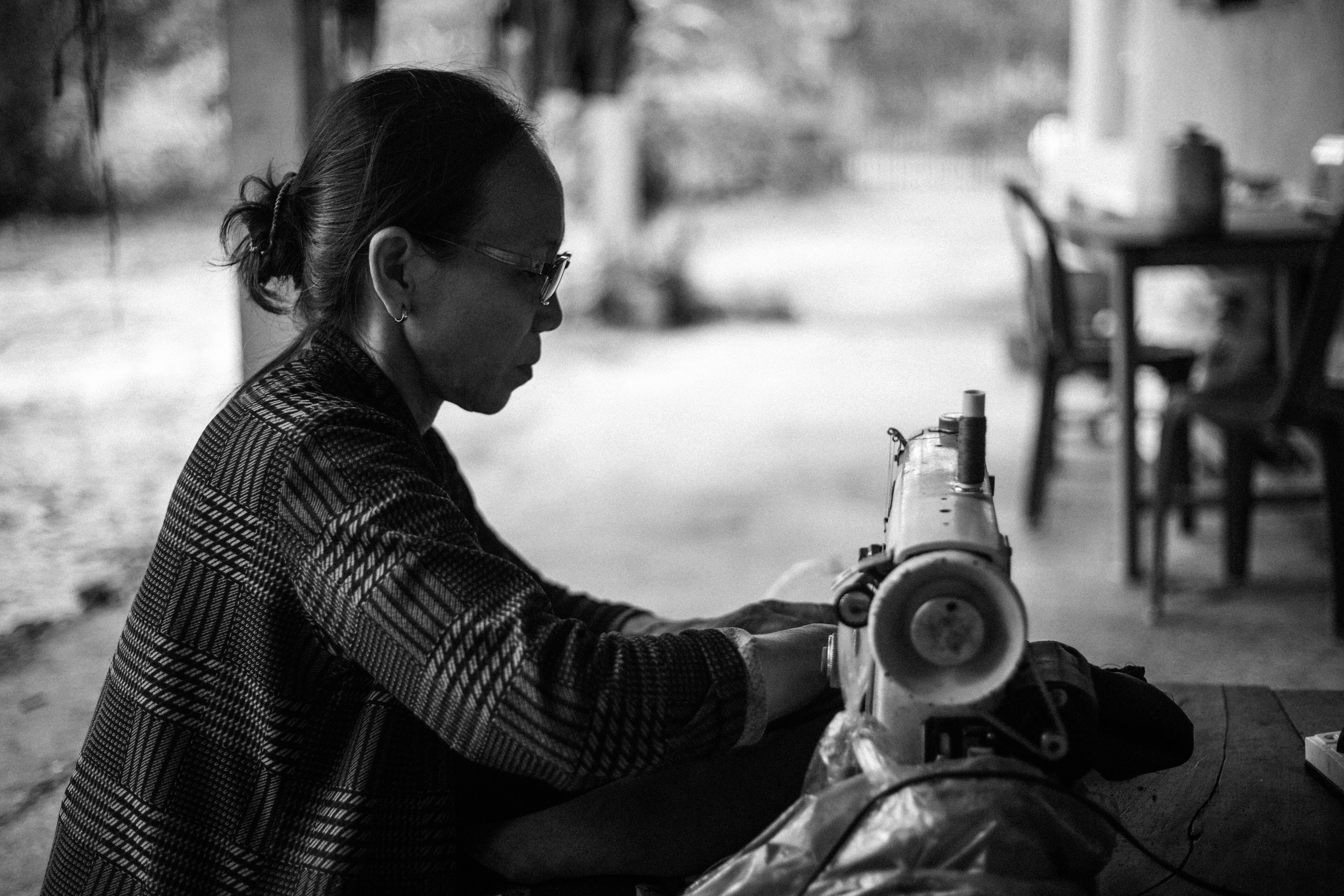 Woman Using an Old Sewing Machine · Free Stock Photo