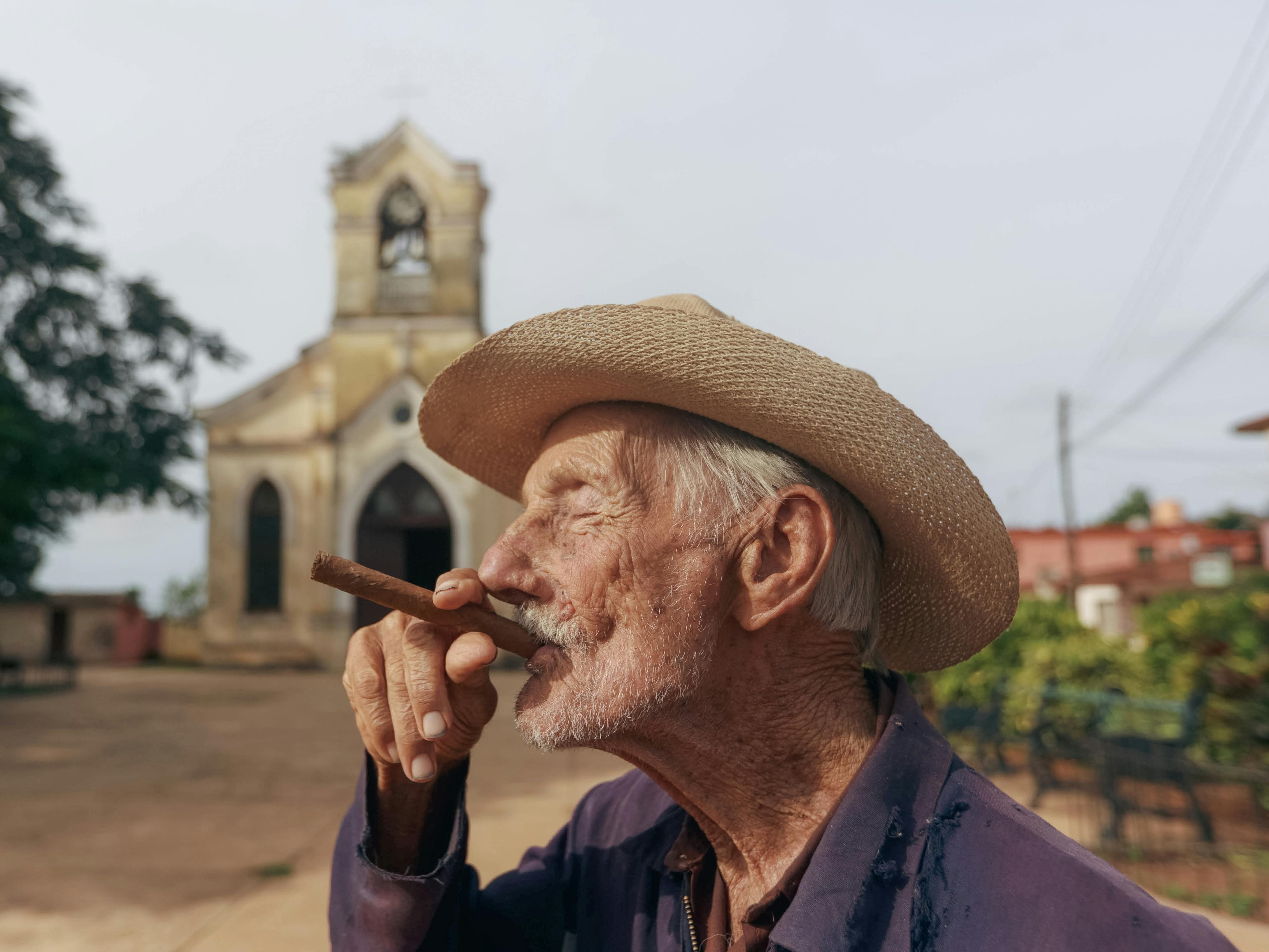 Man in Hat Smoking Cigar · Free Stock Photo