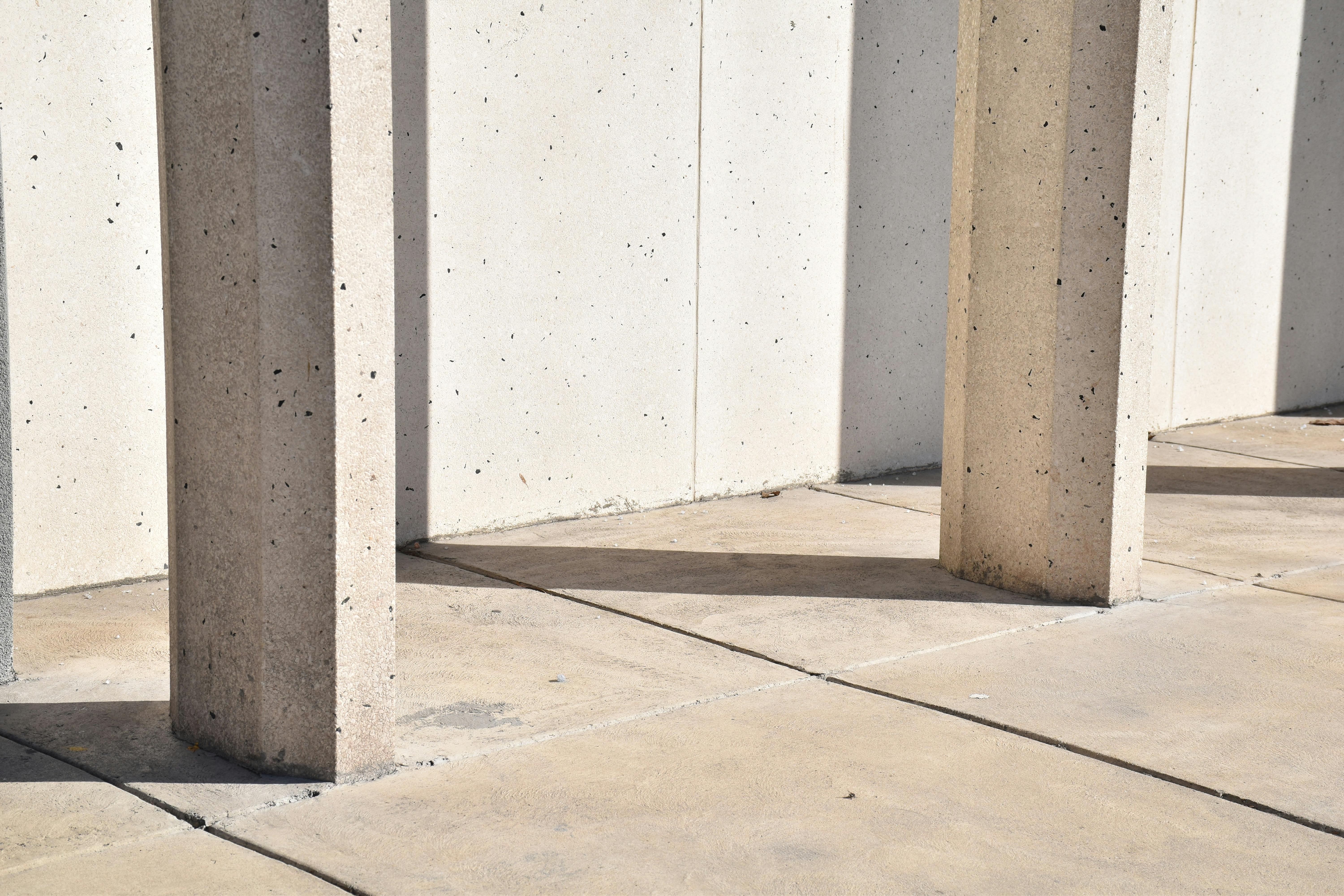 Concrete Pillars Near White Wall in Close-up Photography · Free Stock Photo