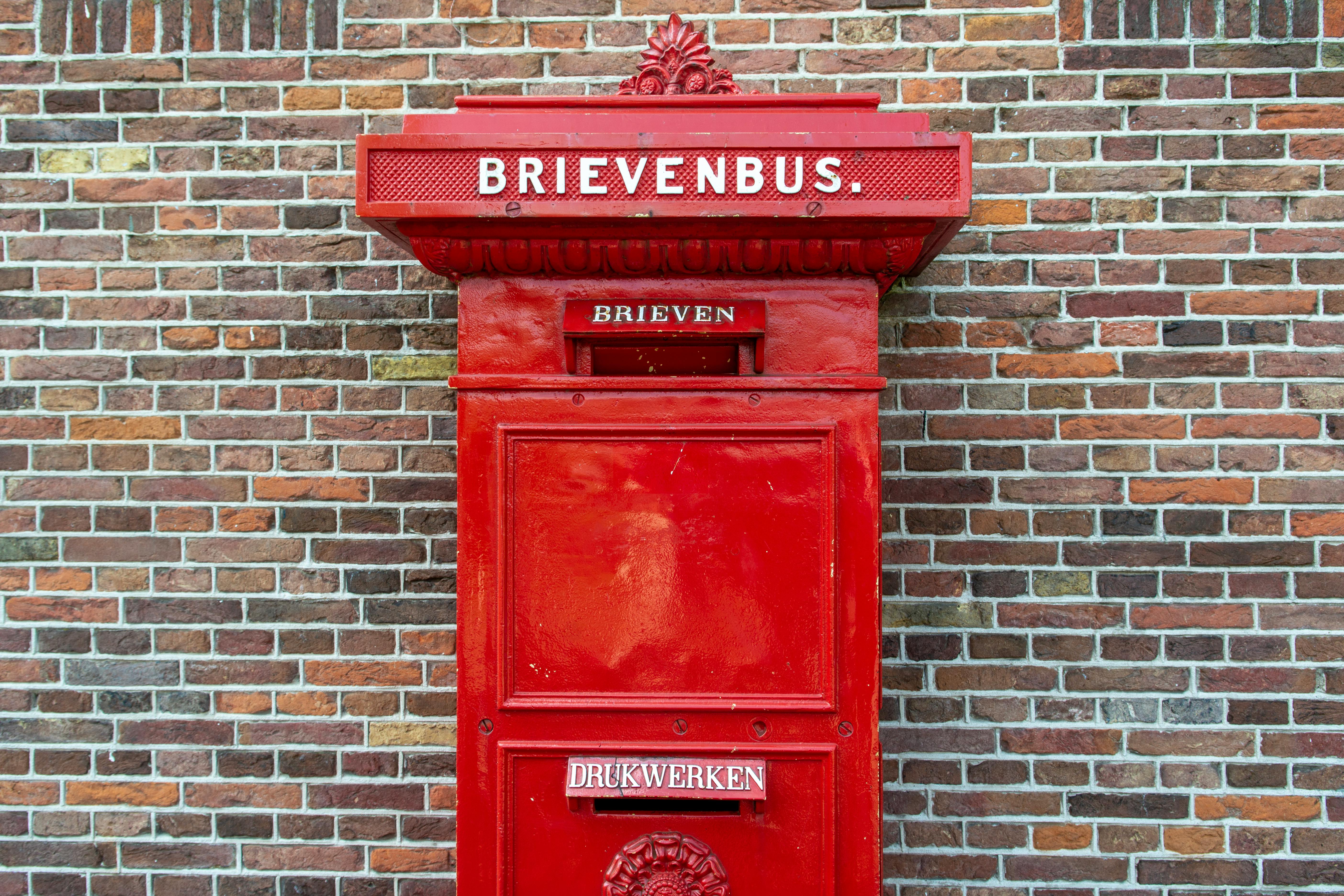 An Old Dutch Red Letter Box against a Brick Wall · Free Stock Photo