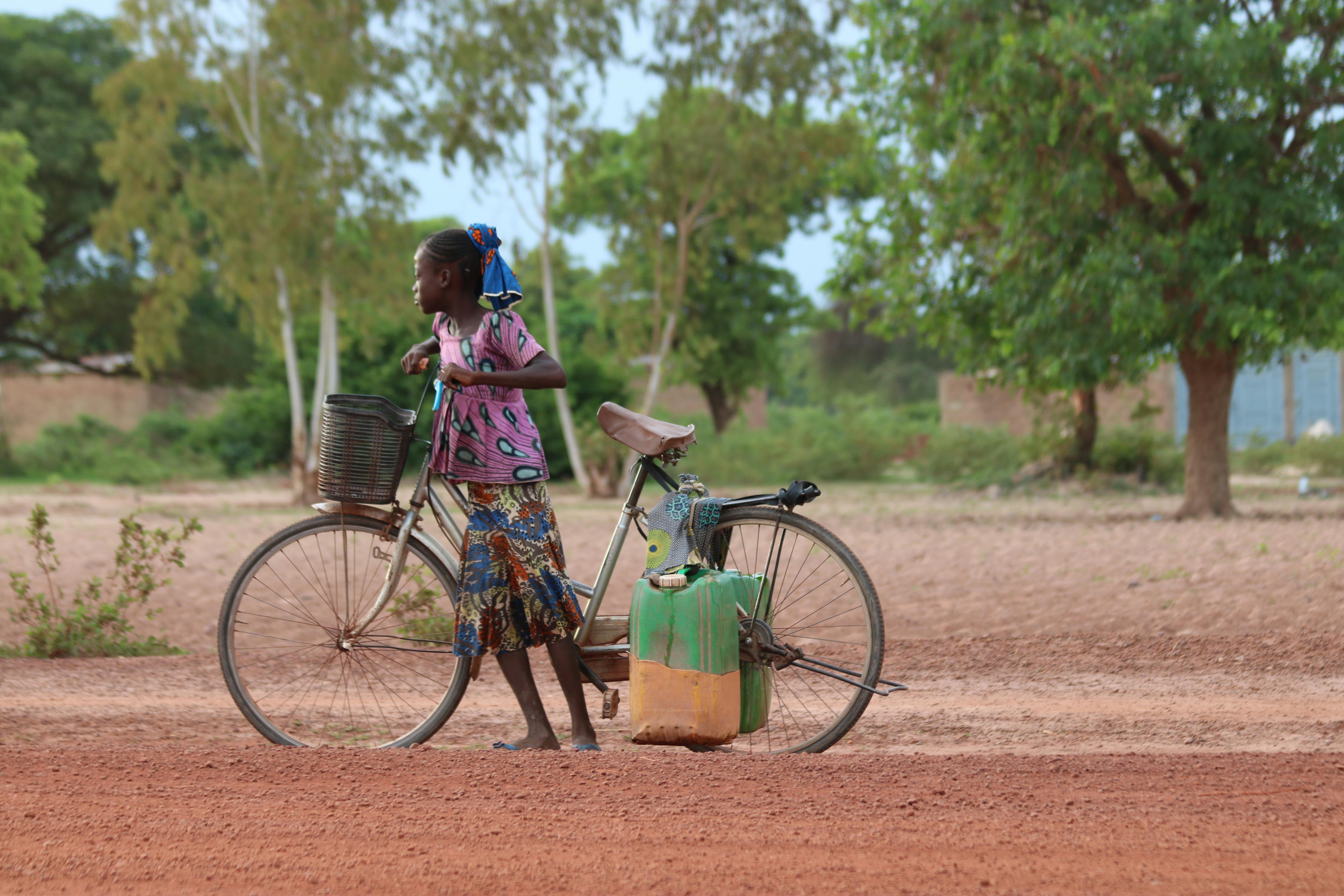 Boy Pushing Girl on Bicycle · Free Stock Photo