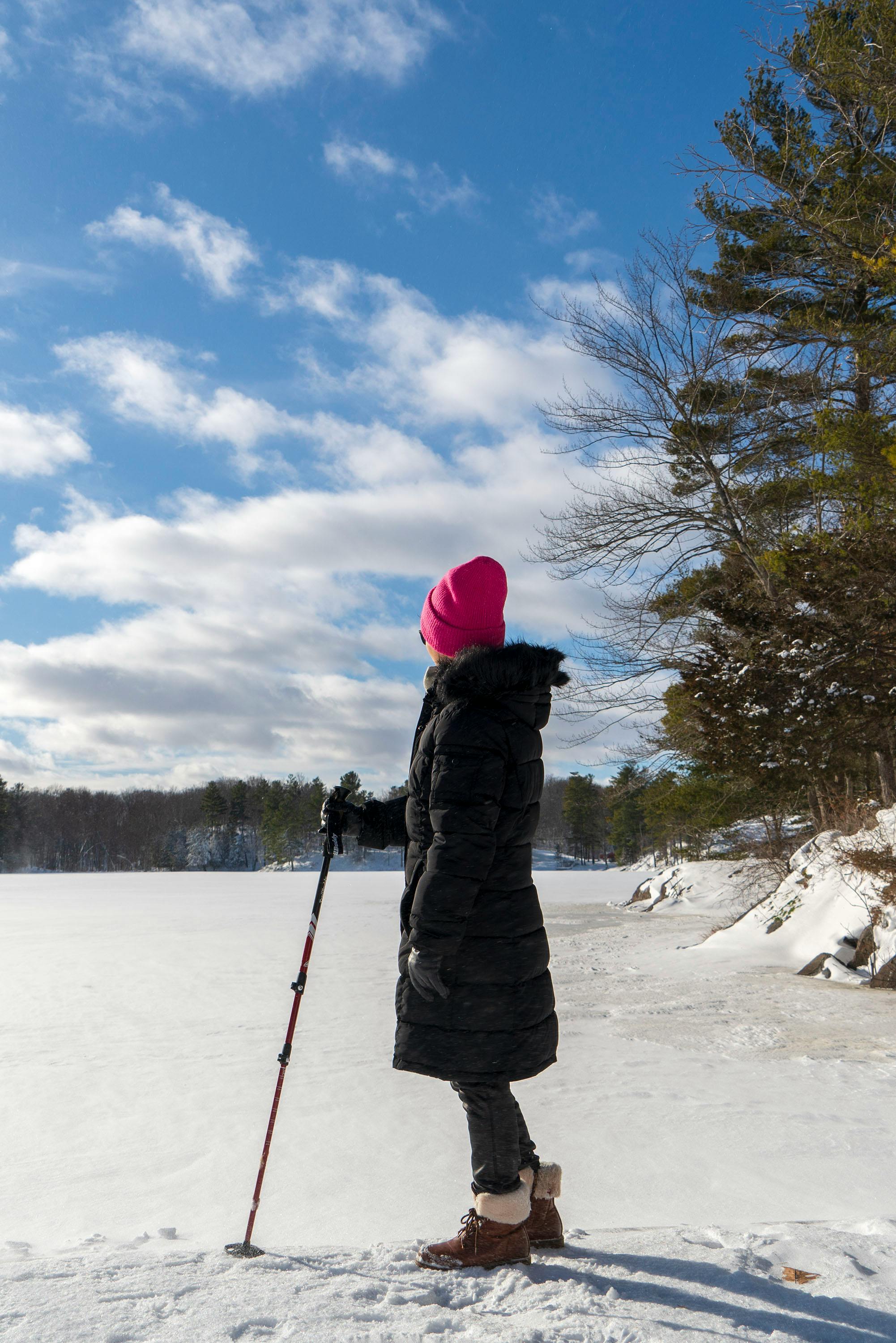 Person Wearing a Puffer Coat Holding a Trekking Pole · Free Stock Photo