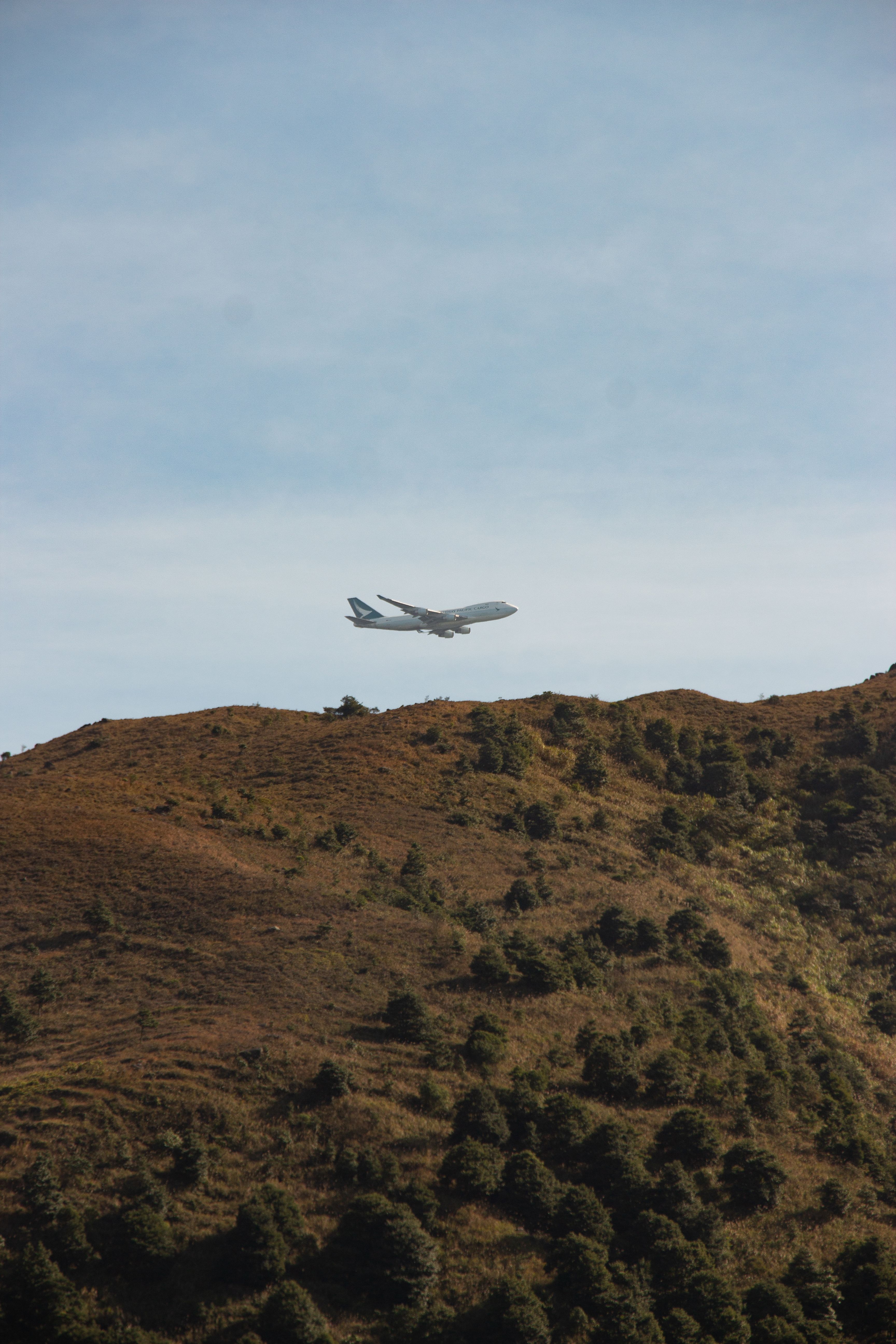 Airplane Flying over a Mountain · Free Stock Photo