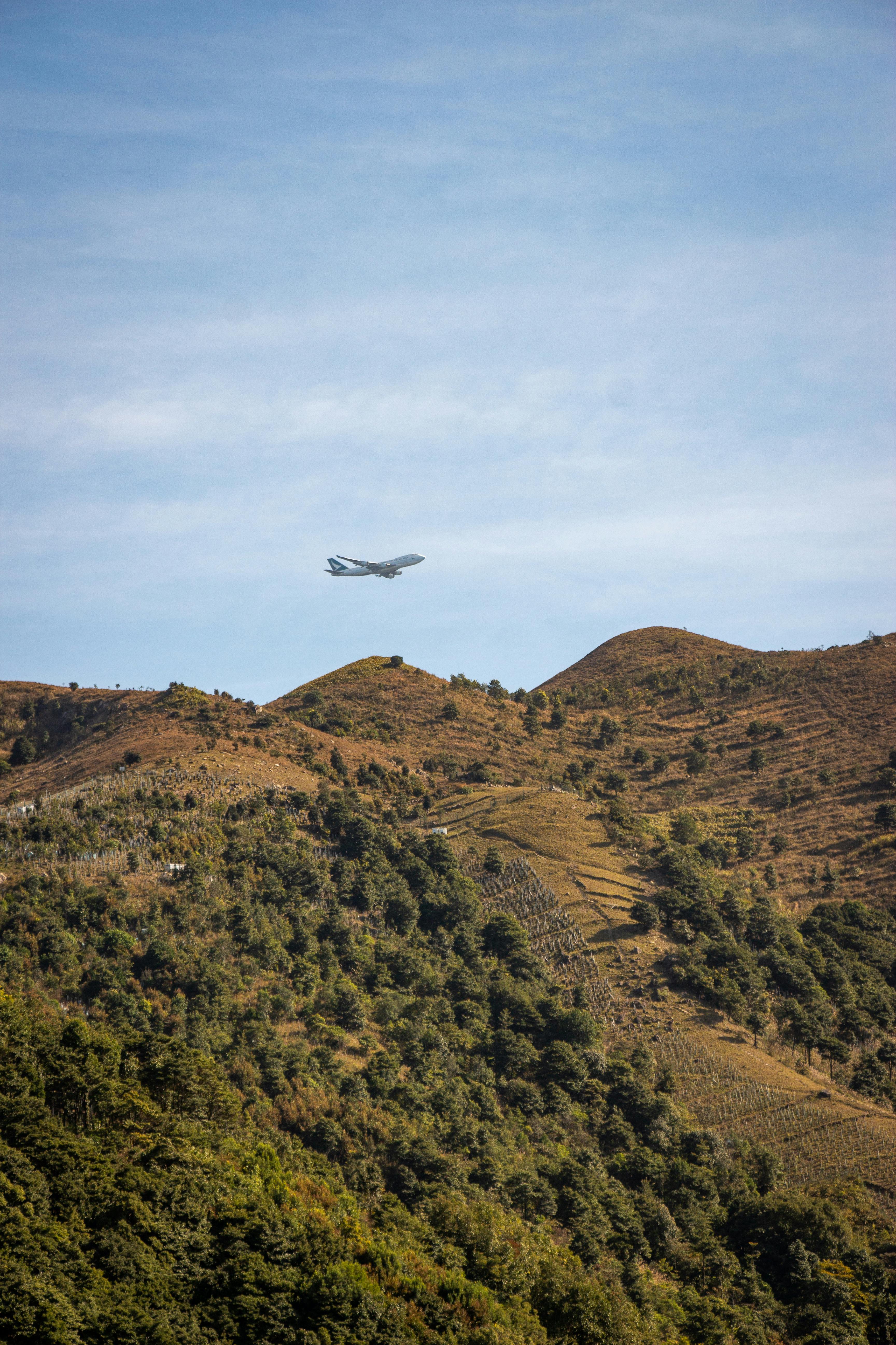 Passenger Airplane Flying over Mountains · Free Stock Photo