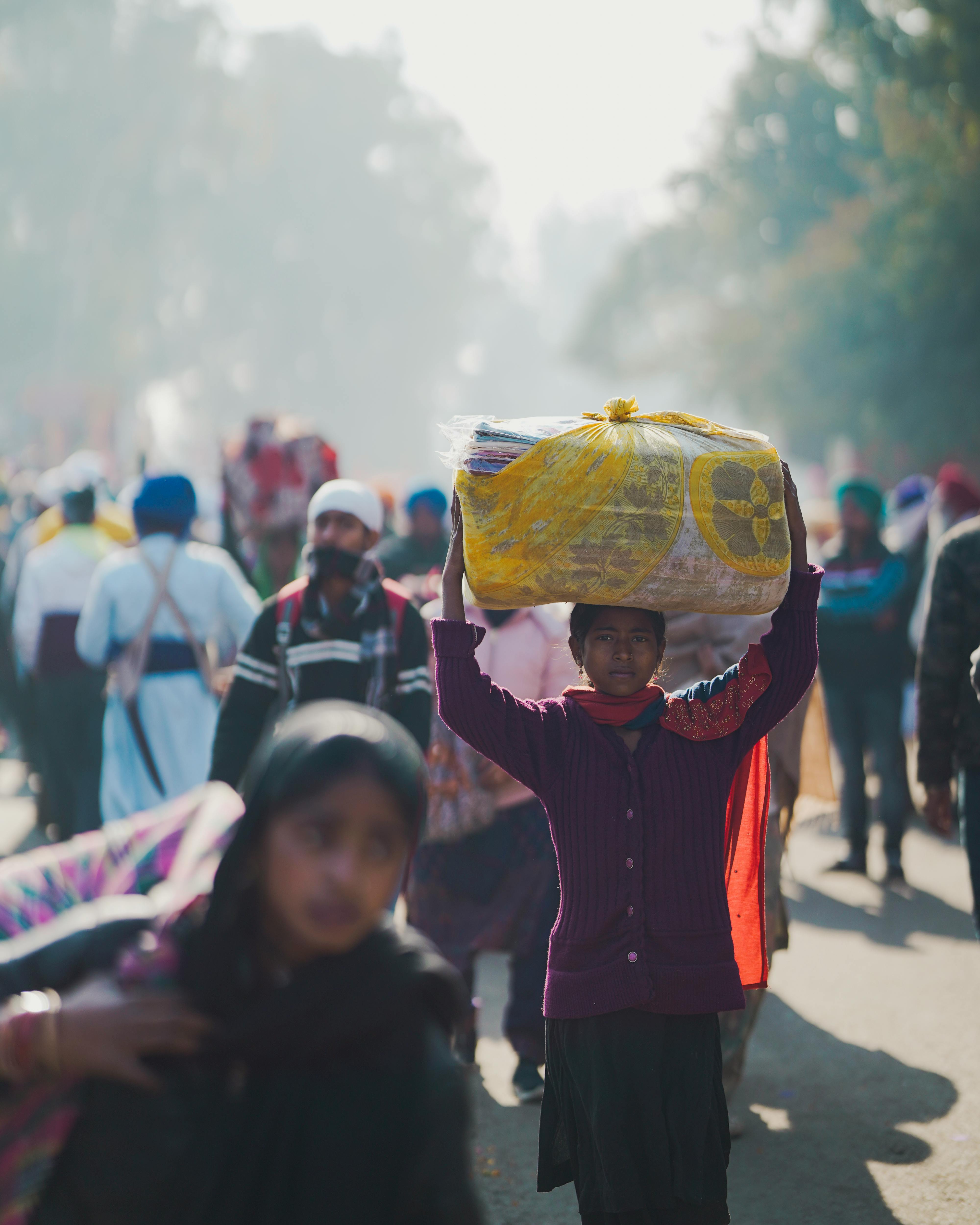 Porter Carrying Heavy Vegetables on Back at Bazaar · Free Stock Photo