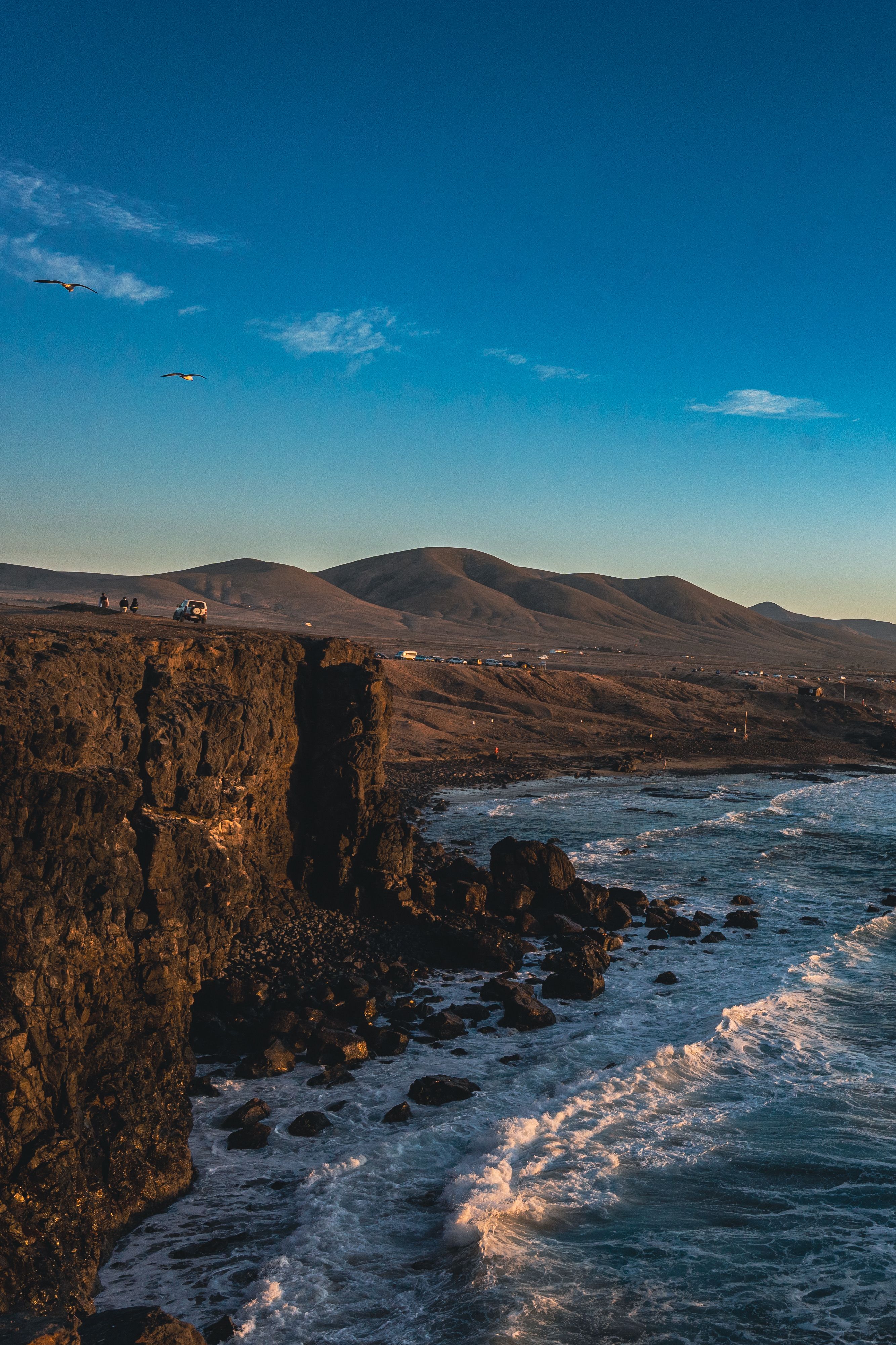 Photo of Cliff on Sea under Blue Sky · Free Stock Photo