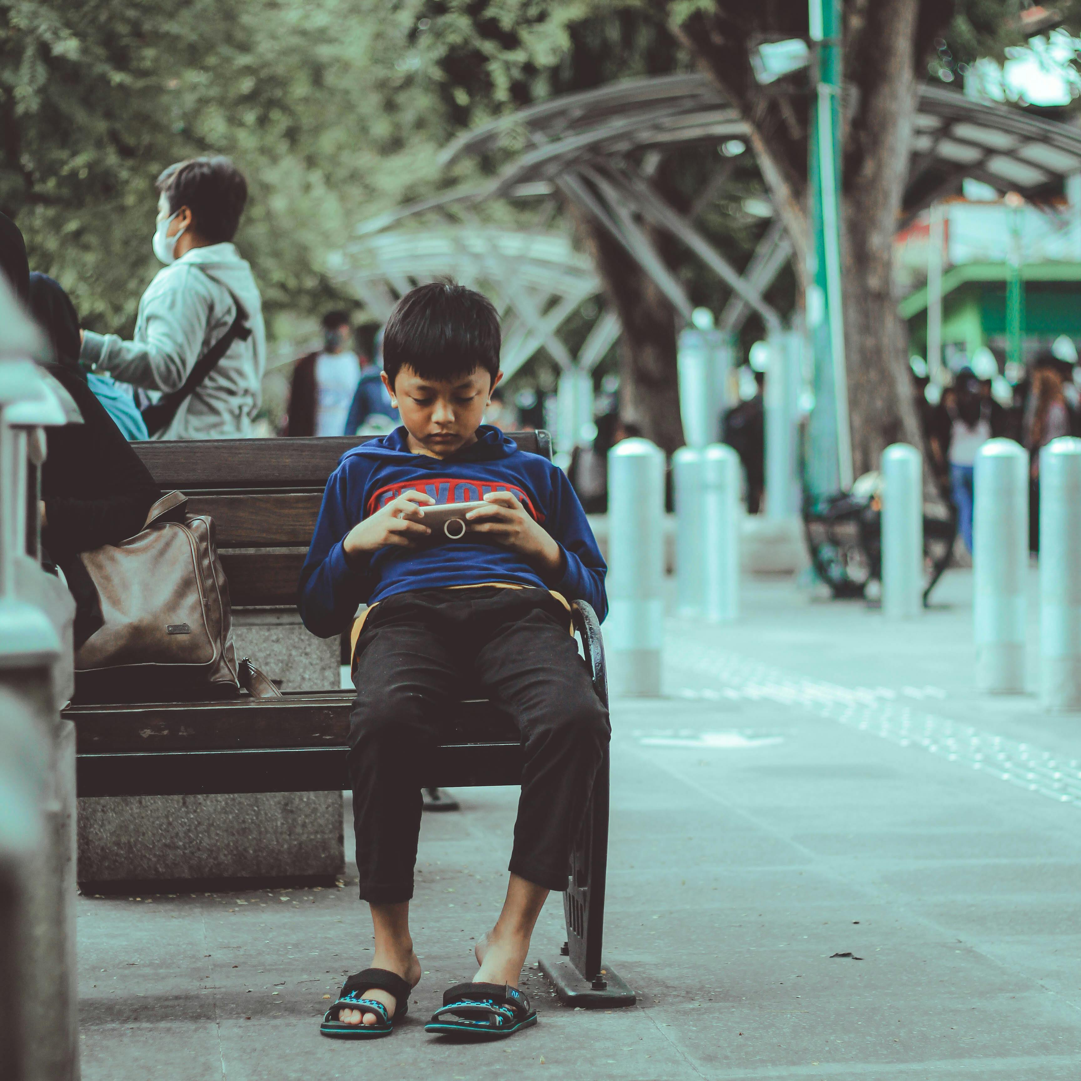 Boy on Wooden Bench in Park · Free Stock Photo