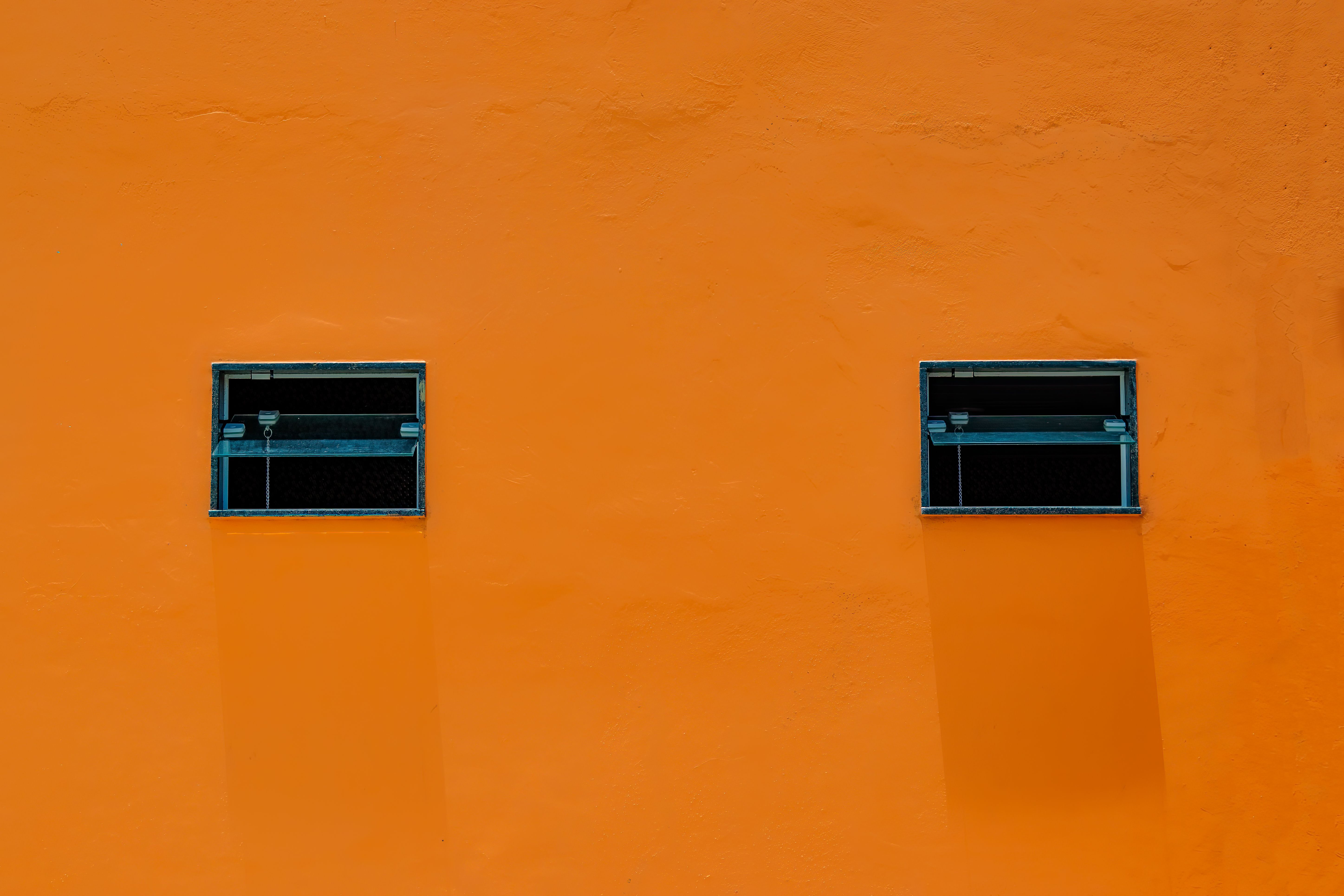 Tower of a Temple behind an Orange Building · Free Stock Photo