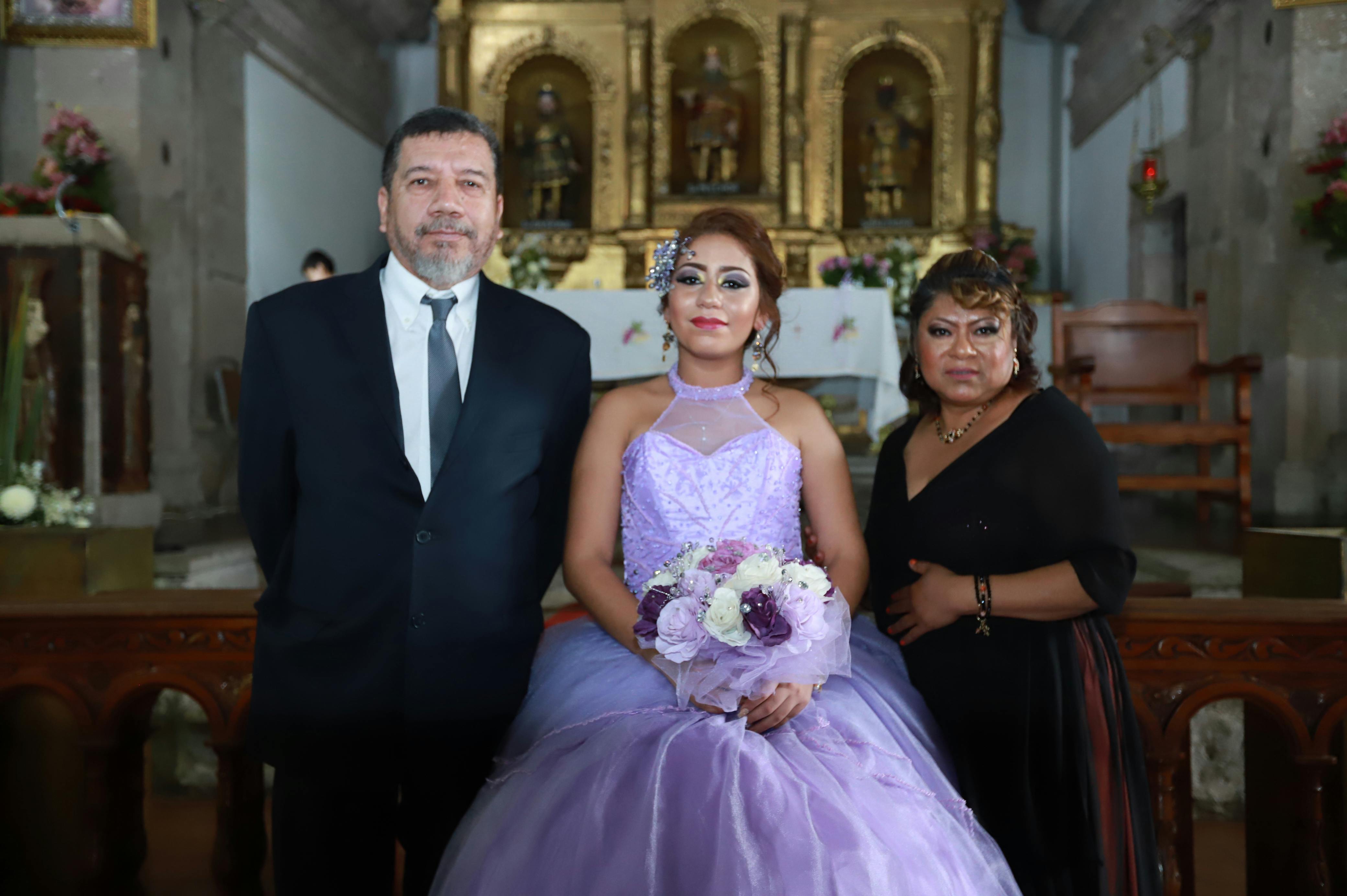 Bride with Parents Posing in Church · Free Stock Photo