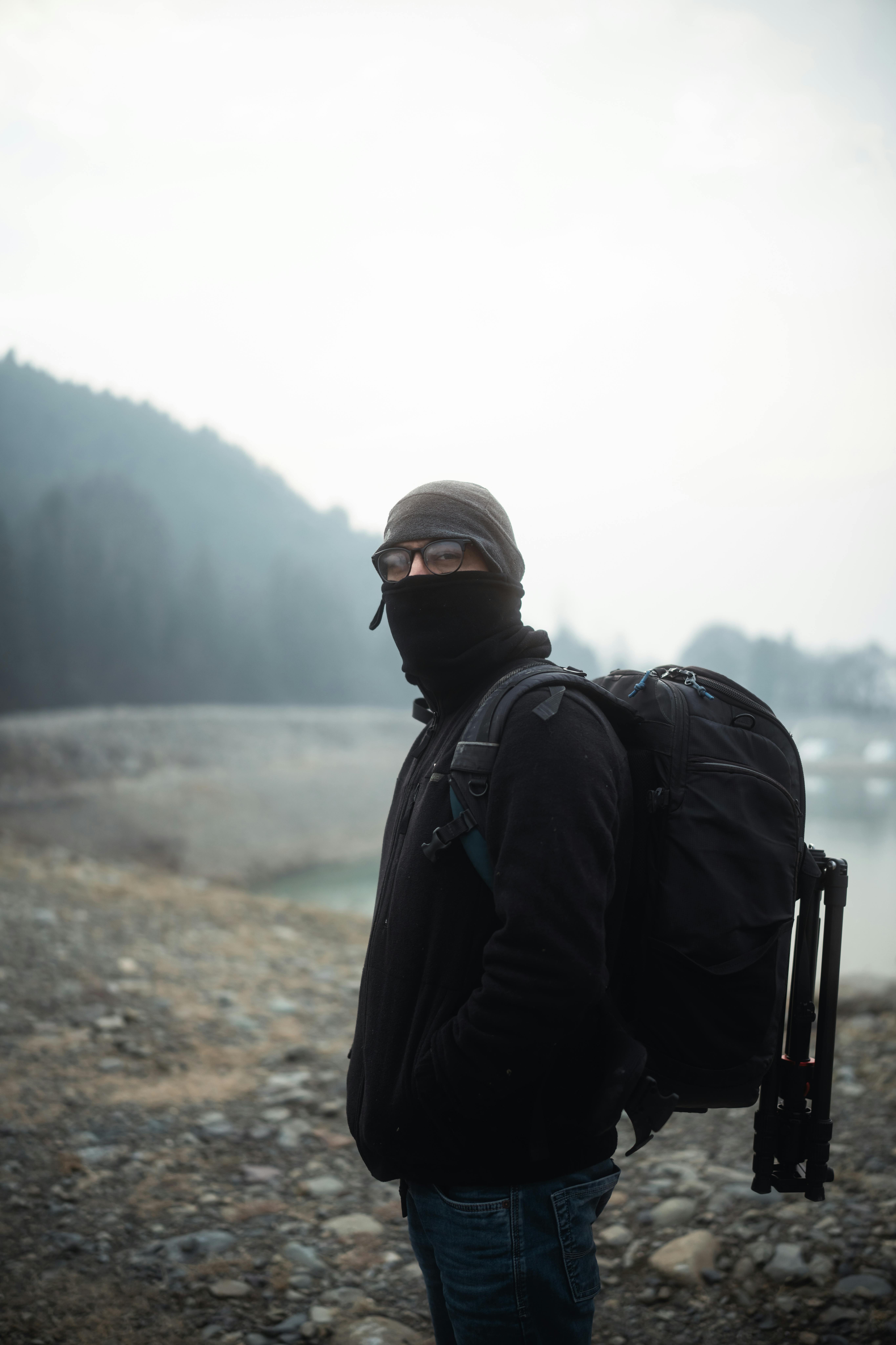 A Man Carrying a Bulky Backpack · Free Stock Photo