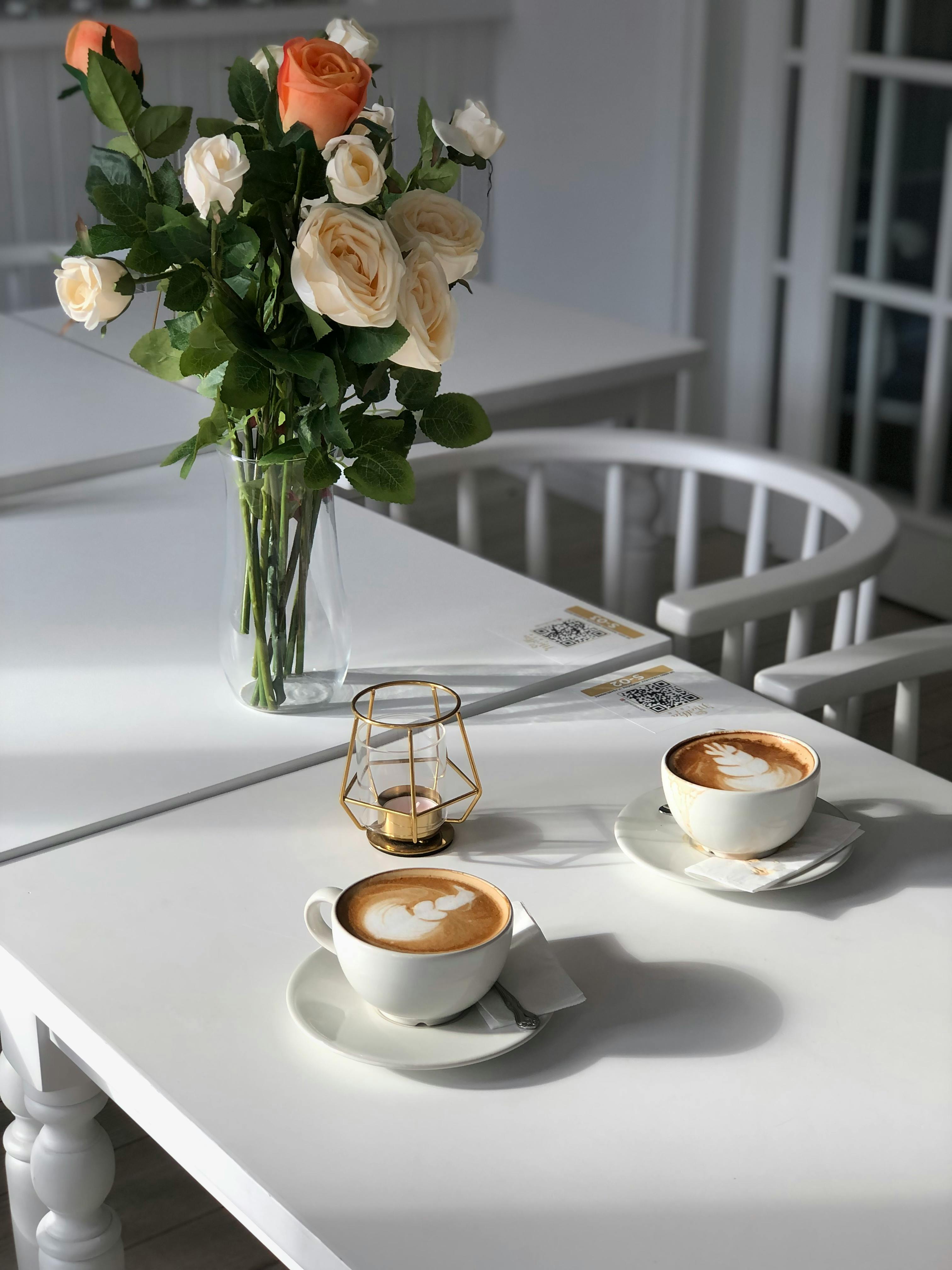 Coffee Cups and Flowers on White Table · Free Stock Photo