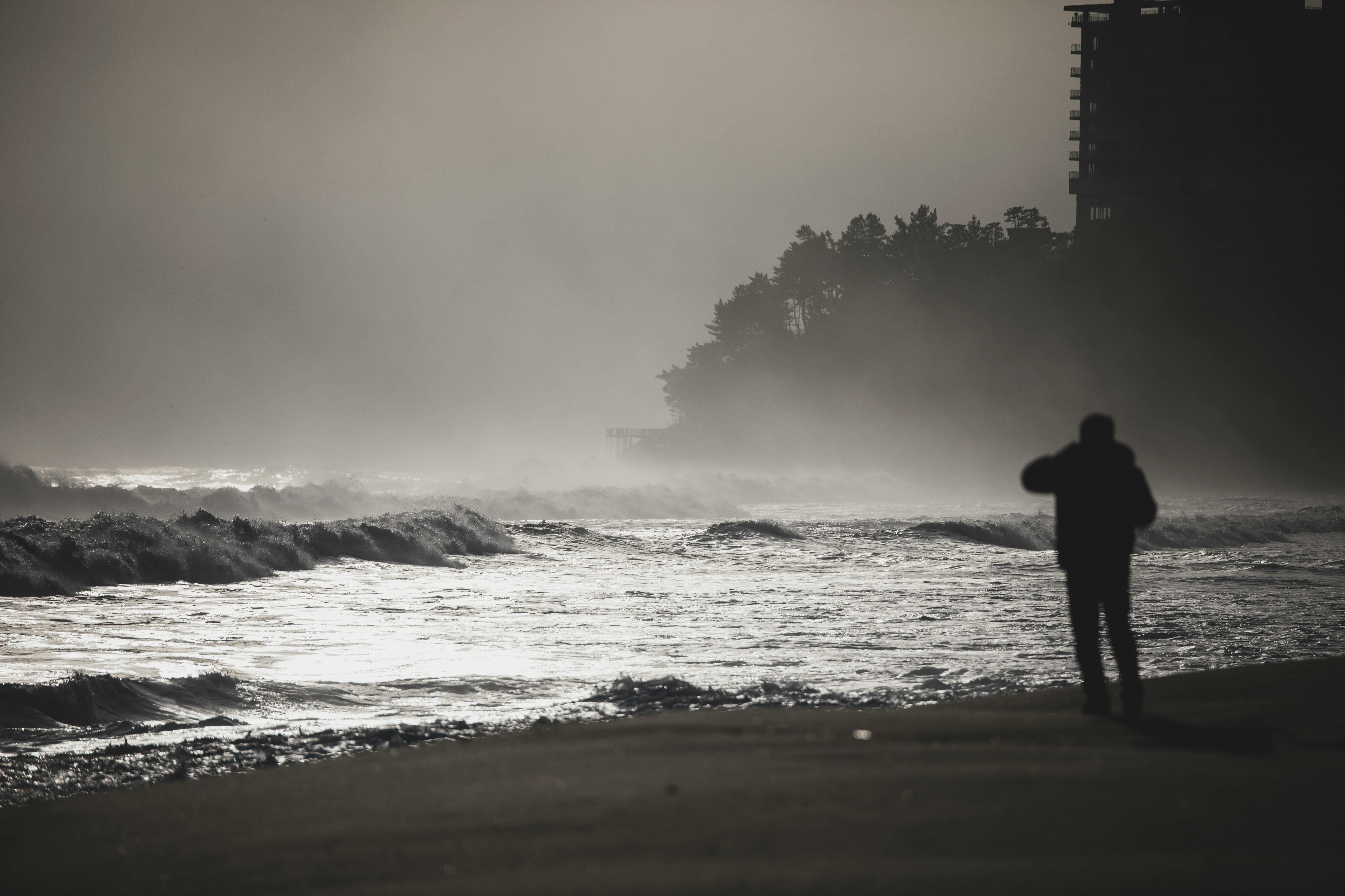 Man at Beach during High Tide · Free Stock Photo