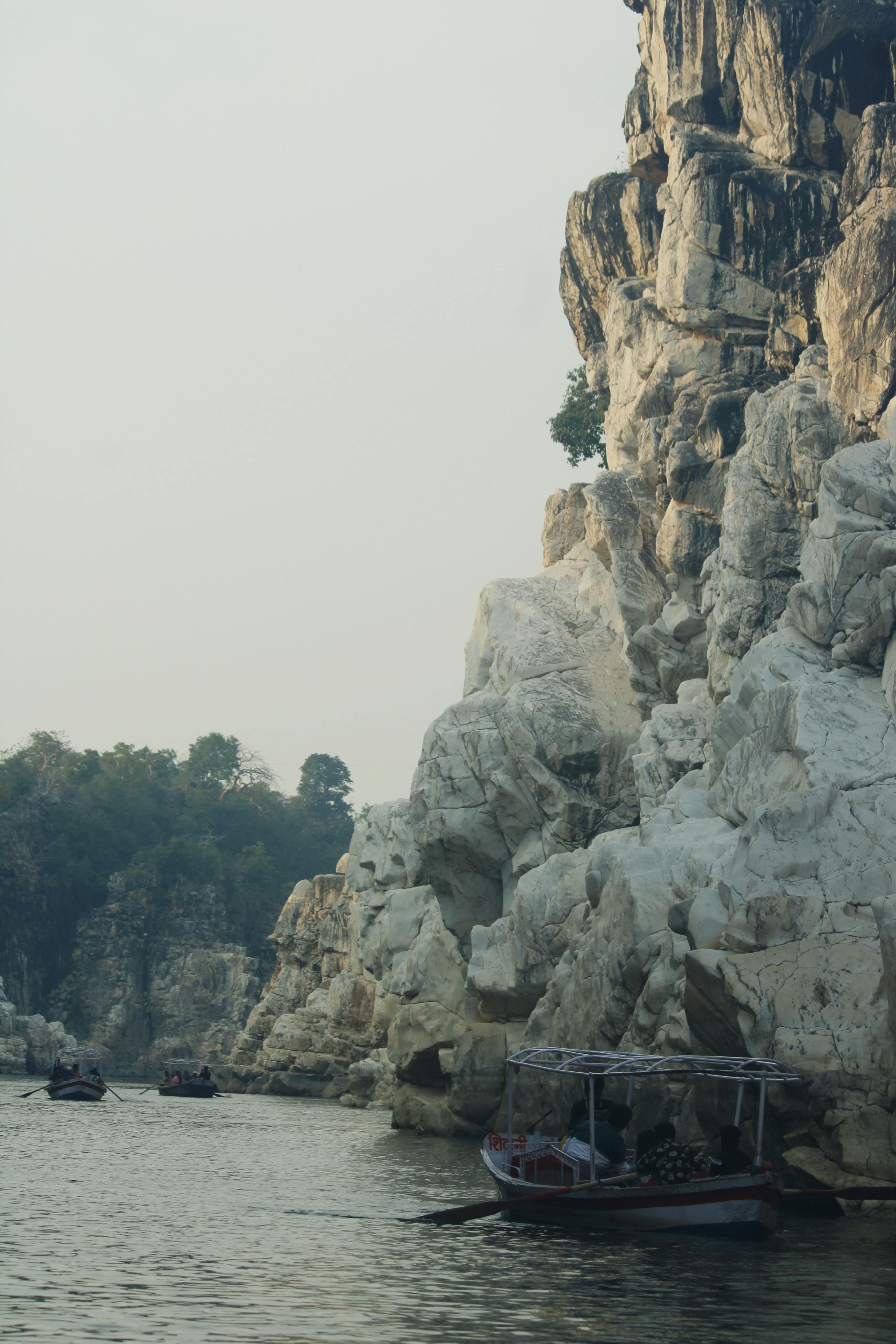 Boat on Sea under Cliff · Free Stock Photo