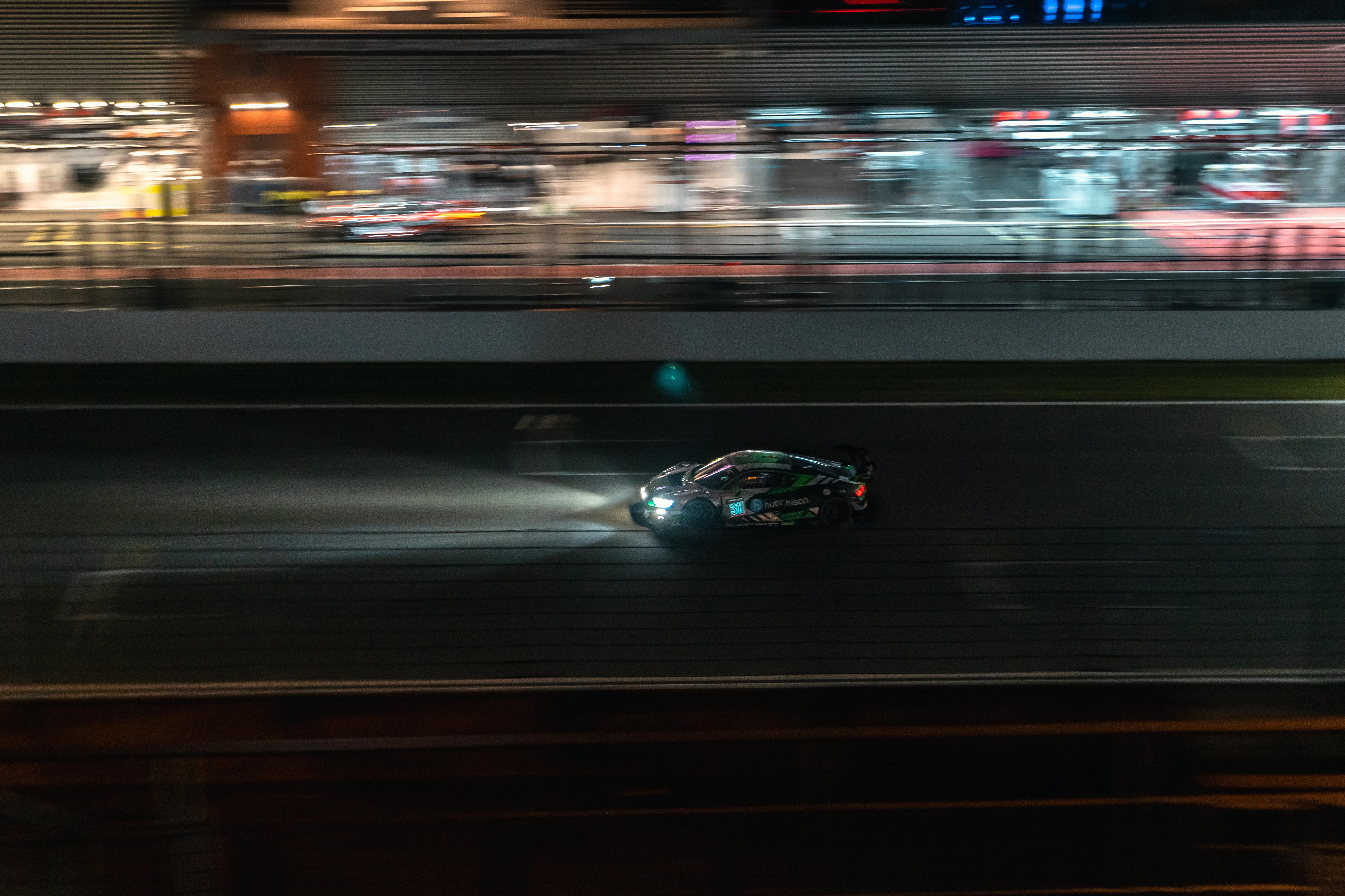 Racecar Driving Fast on a Race Track · Free Stock Photo