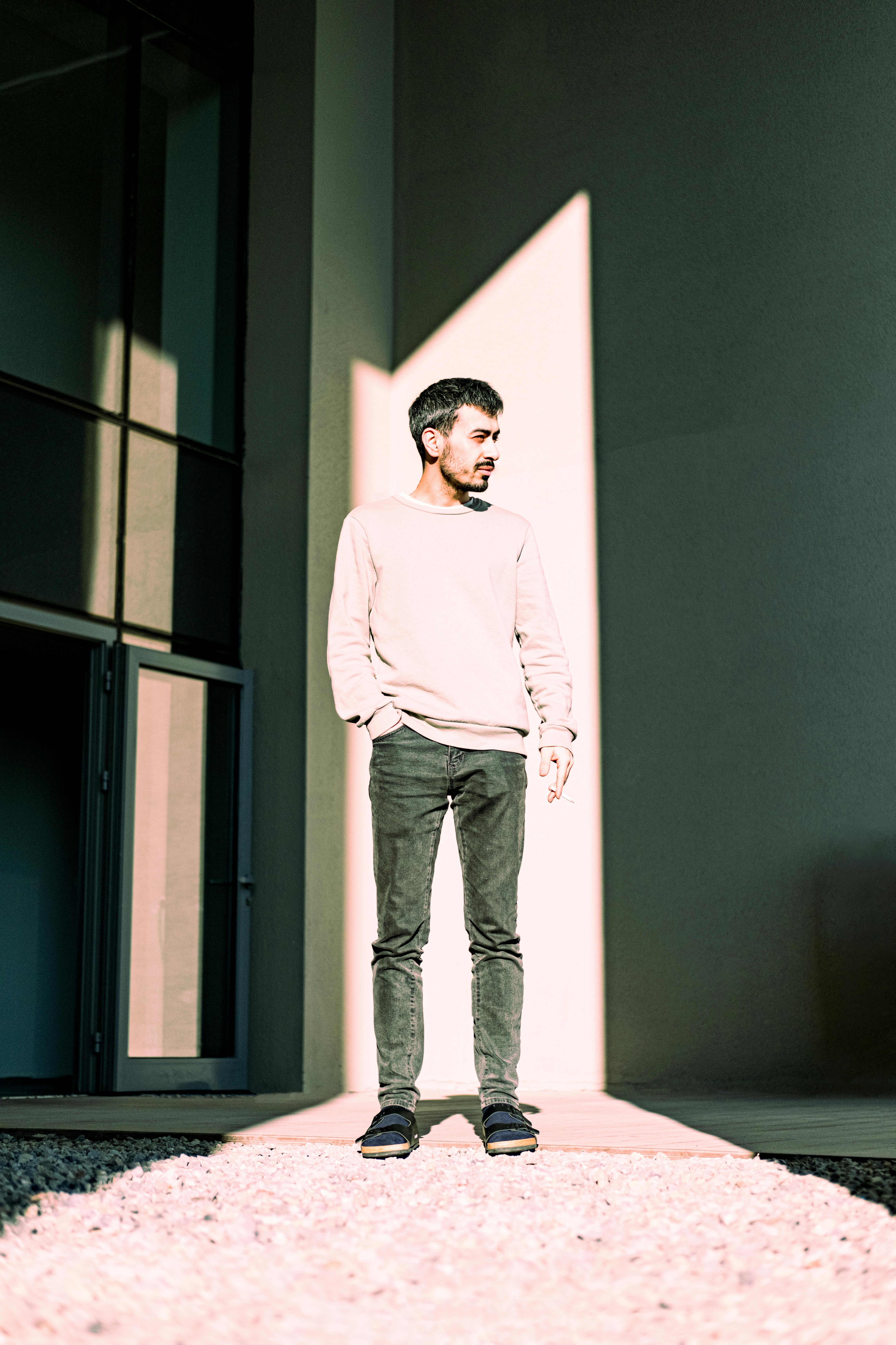 Man Standing on Light Outdoors · Free Stock Photo