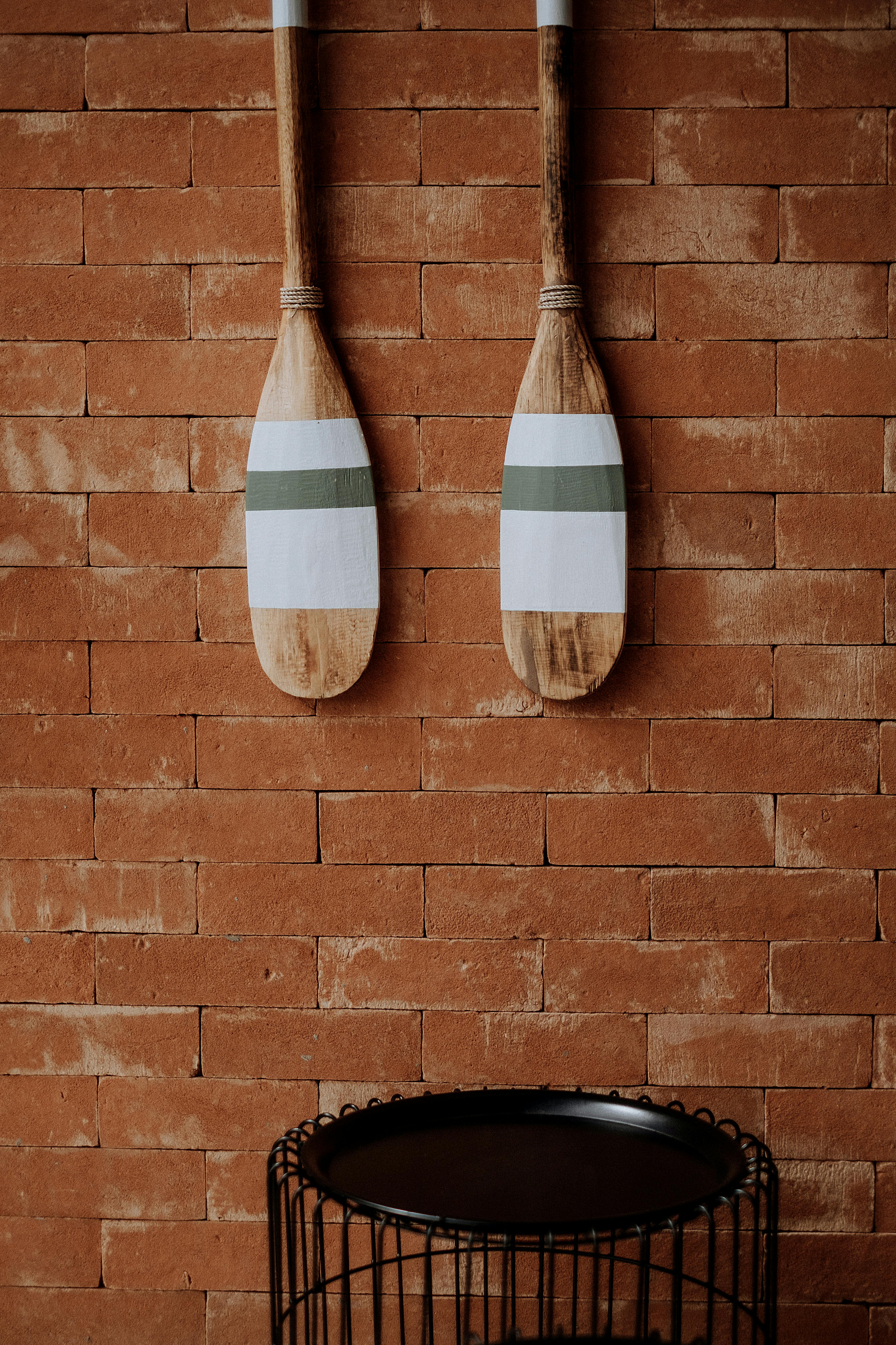 Paddles on Red Brick Wall · Free Stock Photo
