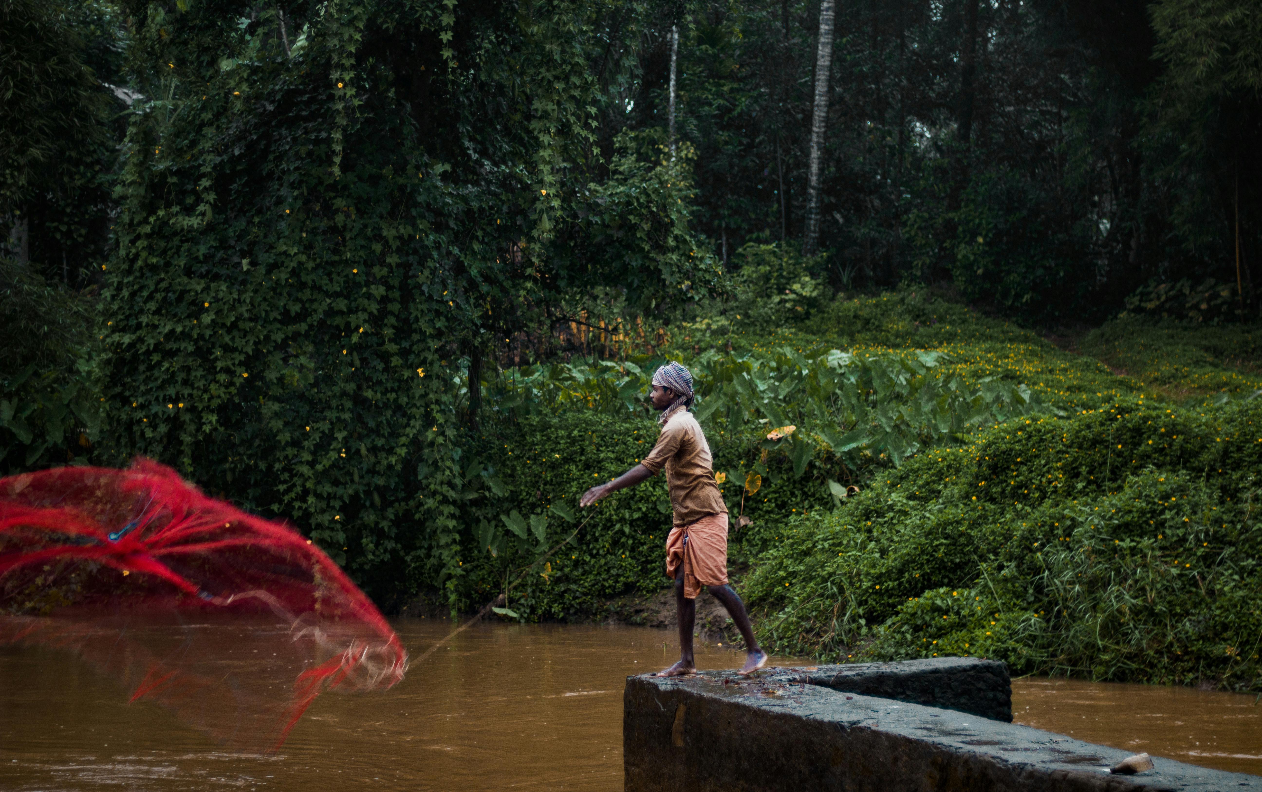 A Man Throwing Fish Net · Free Stock Photo