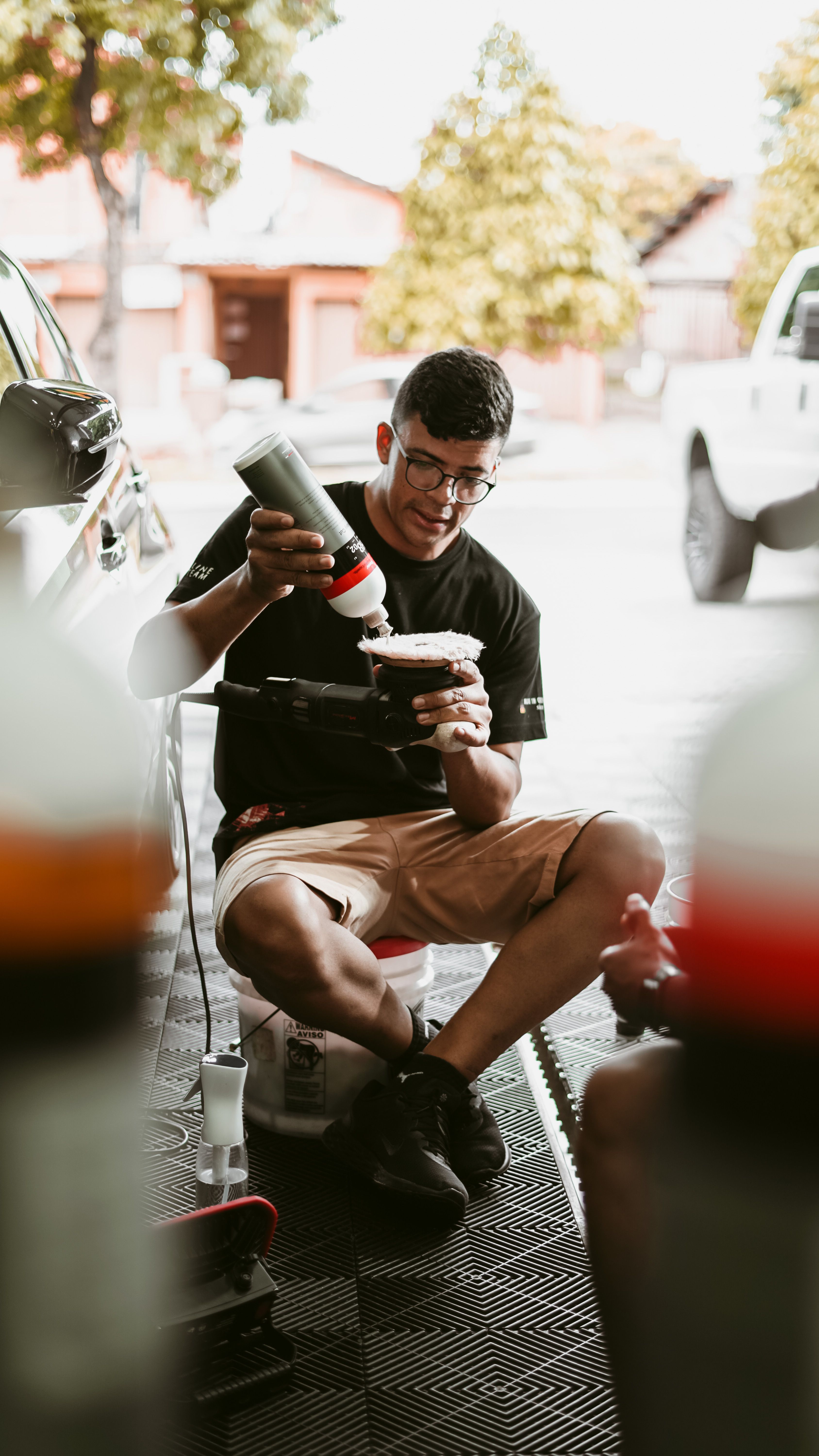 Men Putting Stickers on a Car · Free Stock Photo