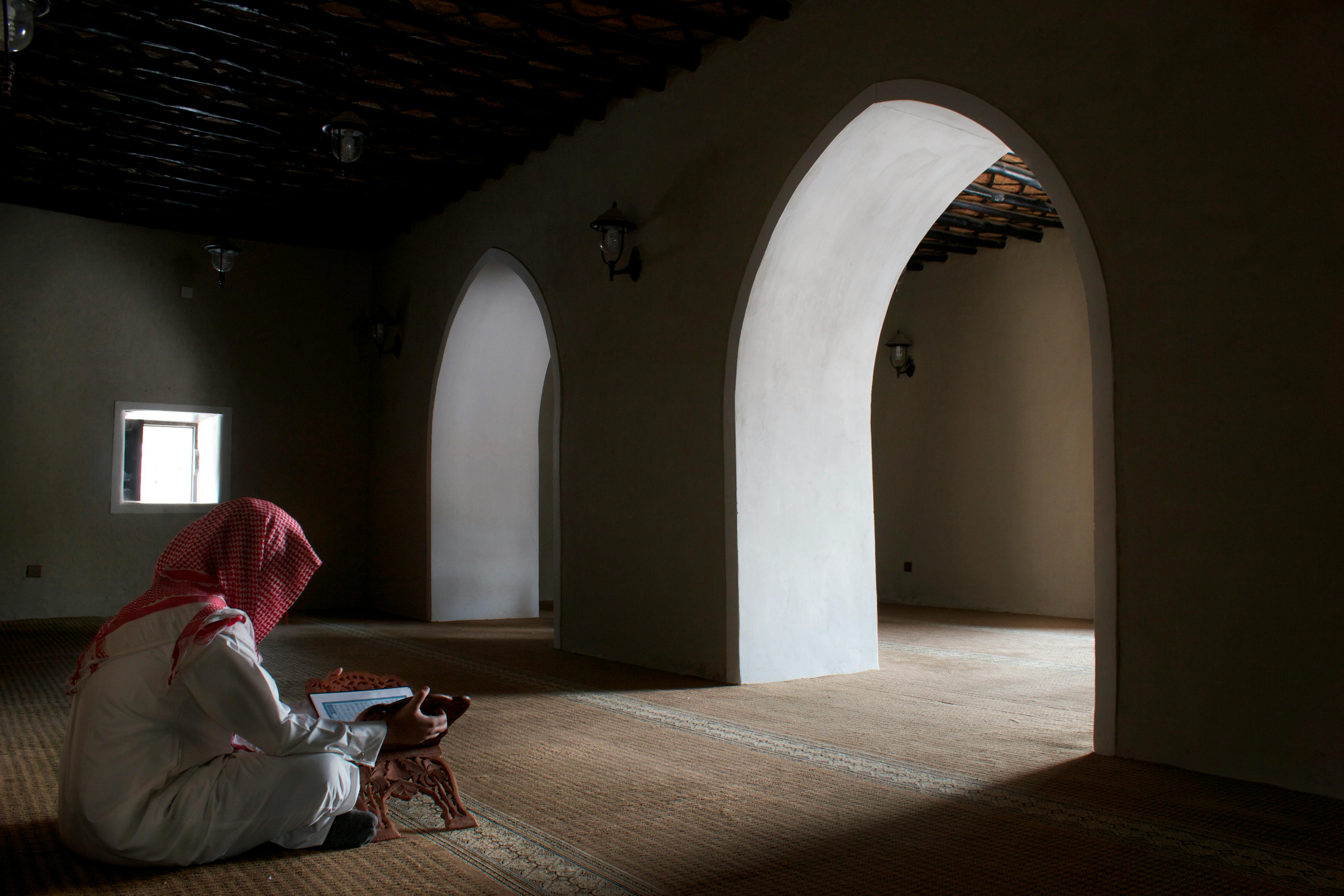 Person Sitting in a Mosque and Reading Koran · Free Stock Photo