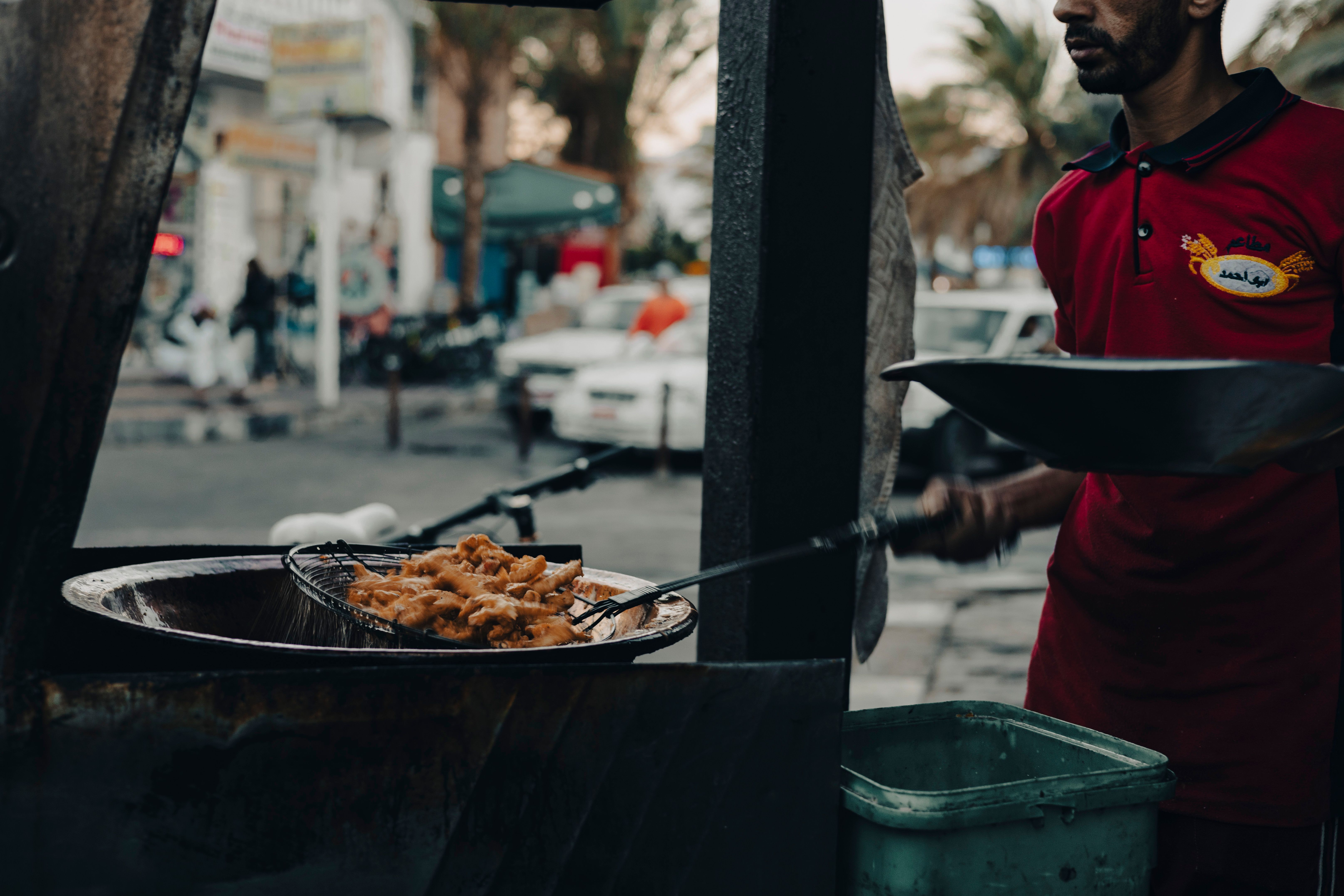 Street Vendor Frying Meat · Free Stock Photo