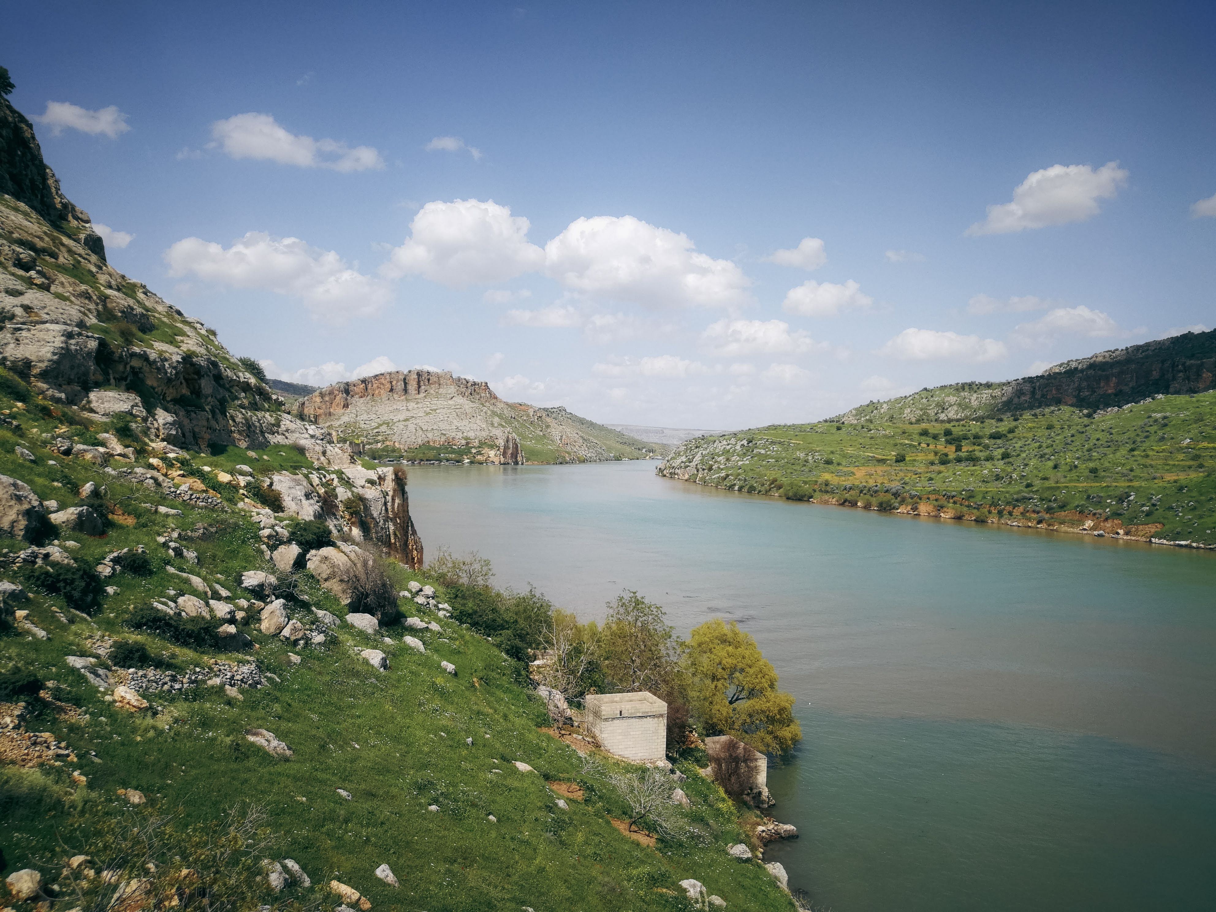 River between Green Hills during Daytime · Free Stock Photo