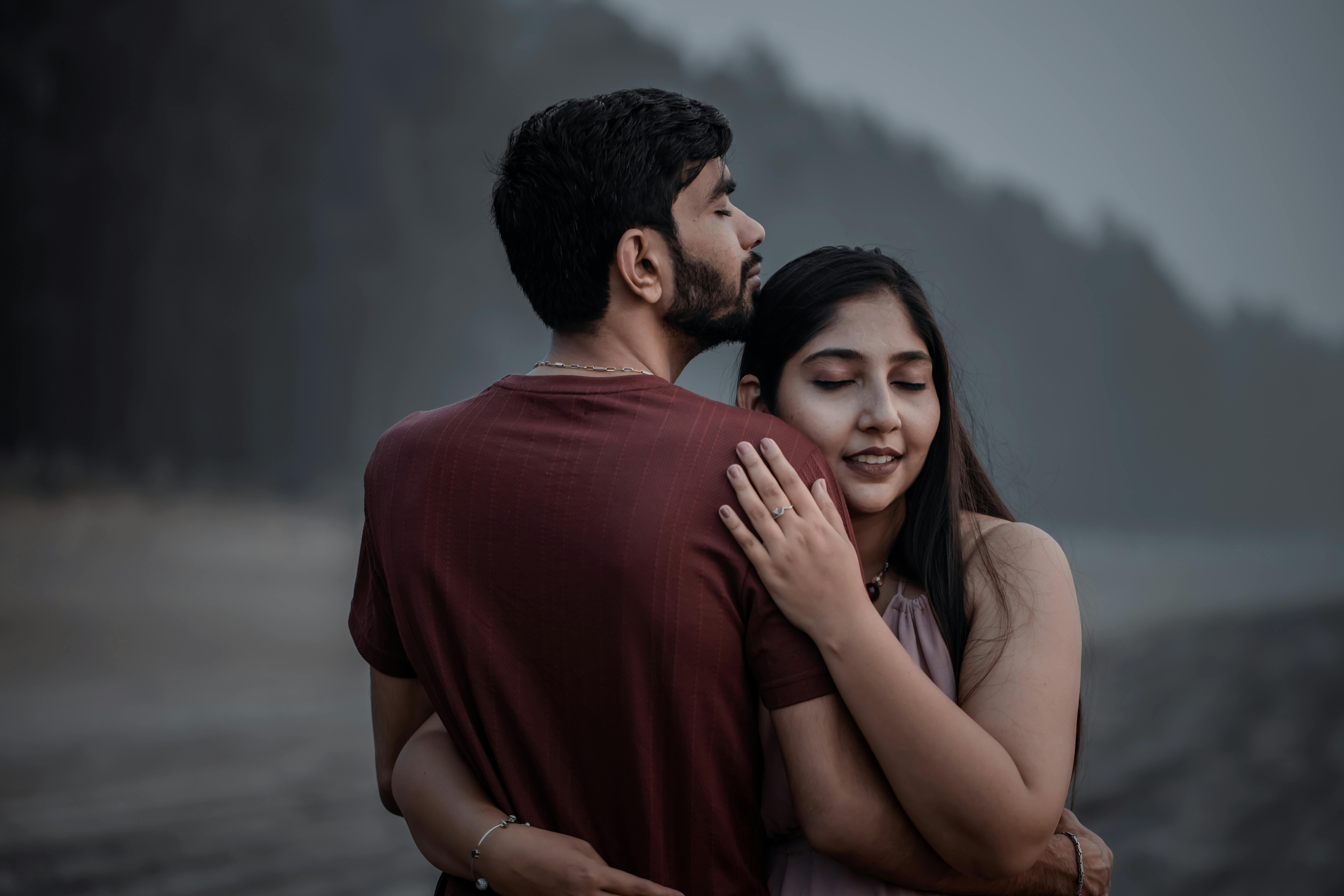 Photo of a Couple Embracing in a Misty Landscape · Free Stock Photo