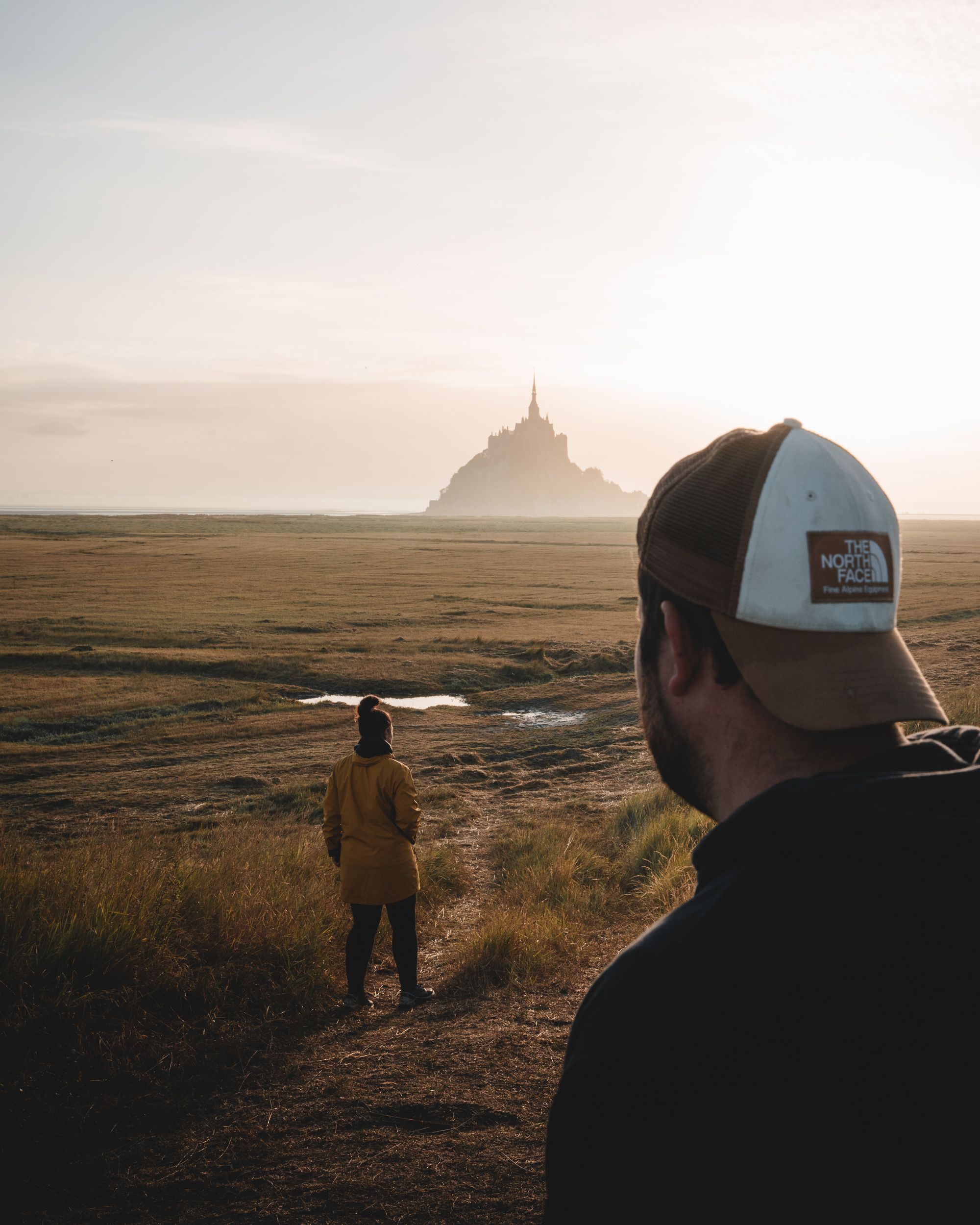Man and Woman on Grassland with Castle behind · Free Stock Photo