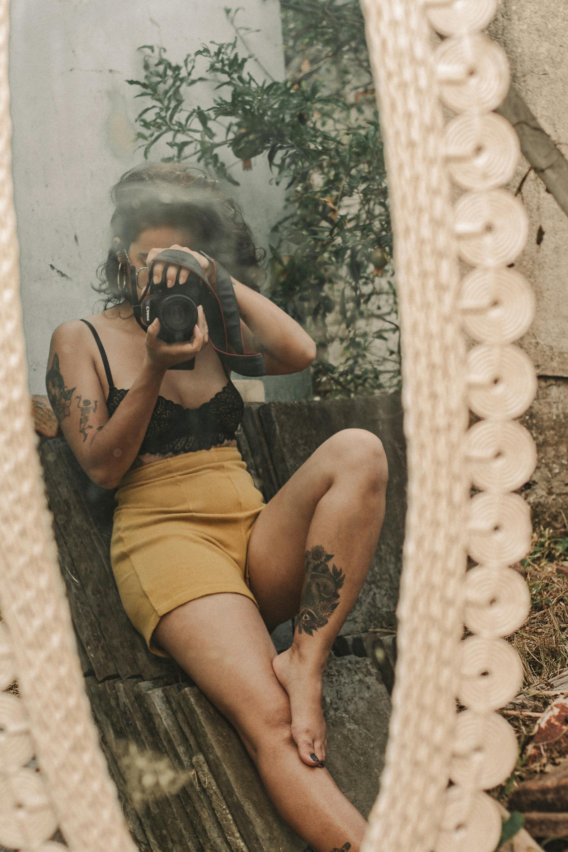 Reflection of a Woman Taking Photos with a Camera · Free Stock Photo