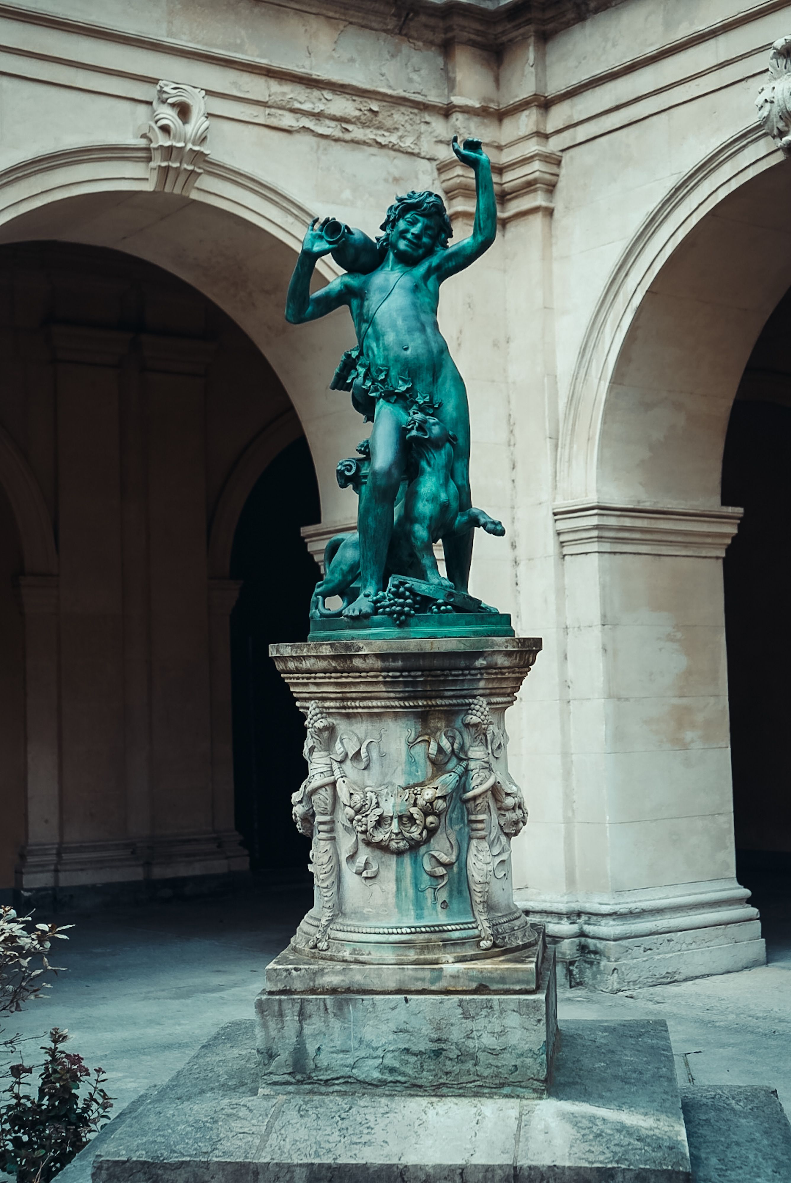 Sculptures on Building near Tree Branches and Leaves · Free Stock Photo